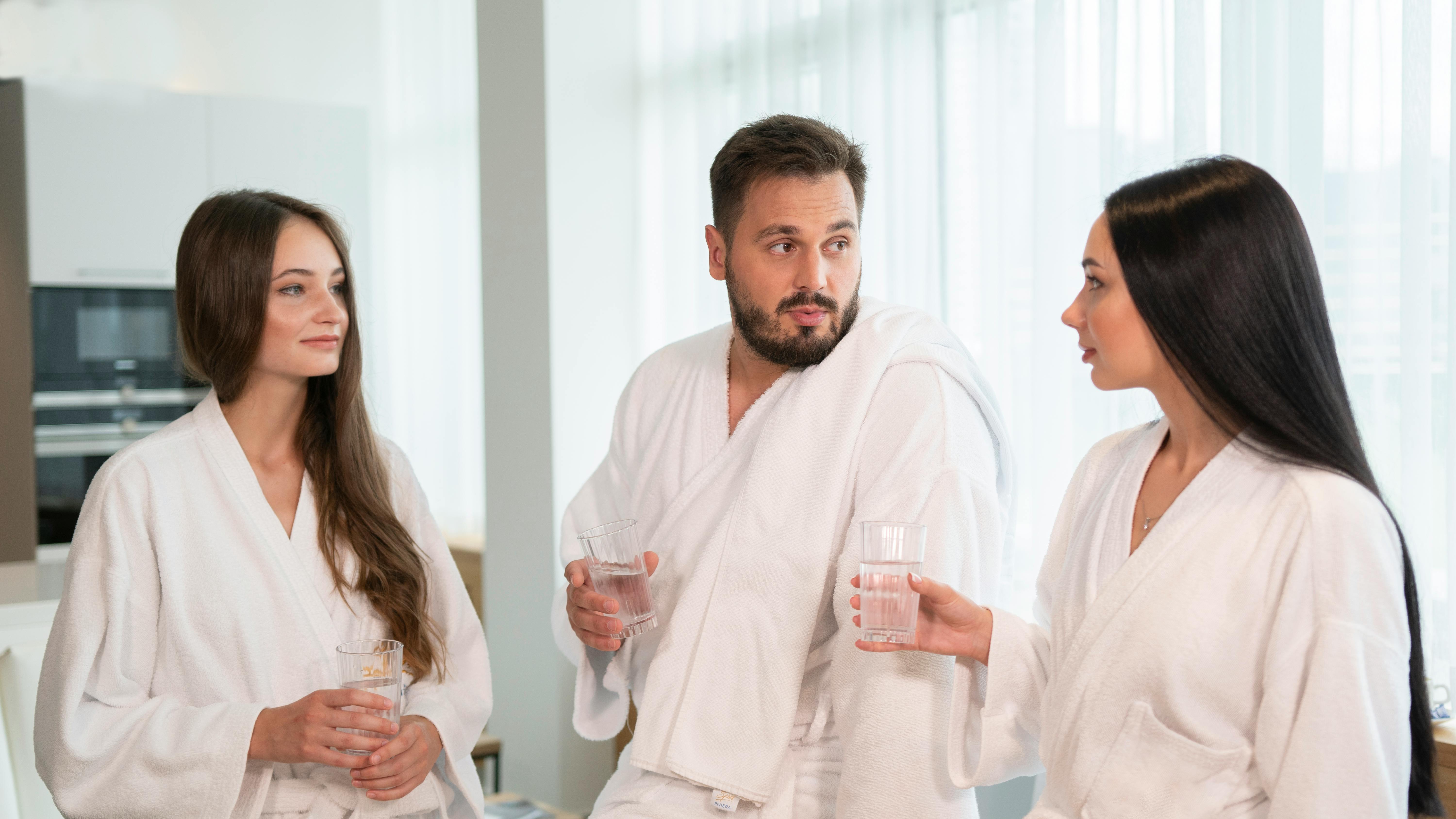 Three People in White Bathrobes Drinking Water from Glasses · Free ...