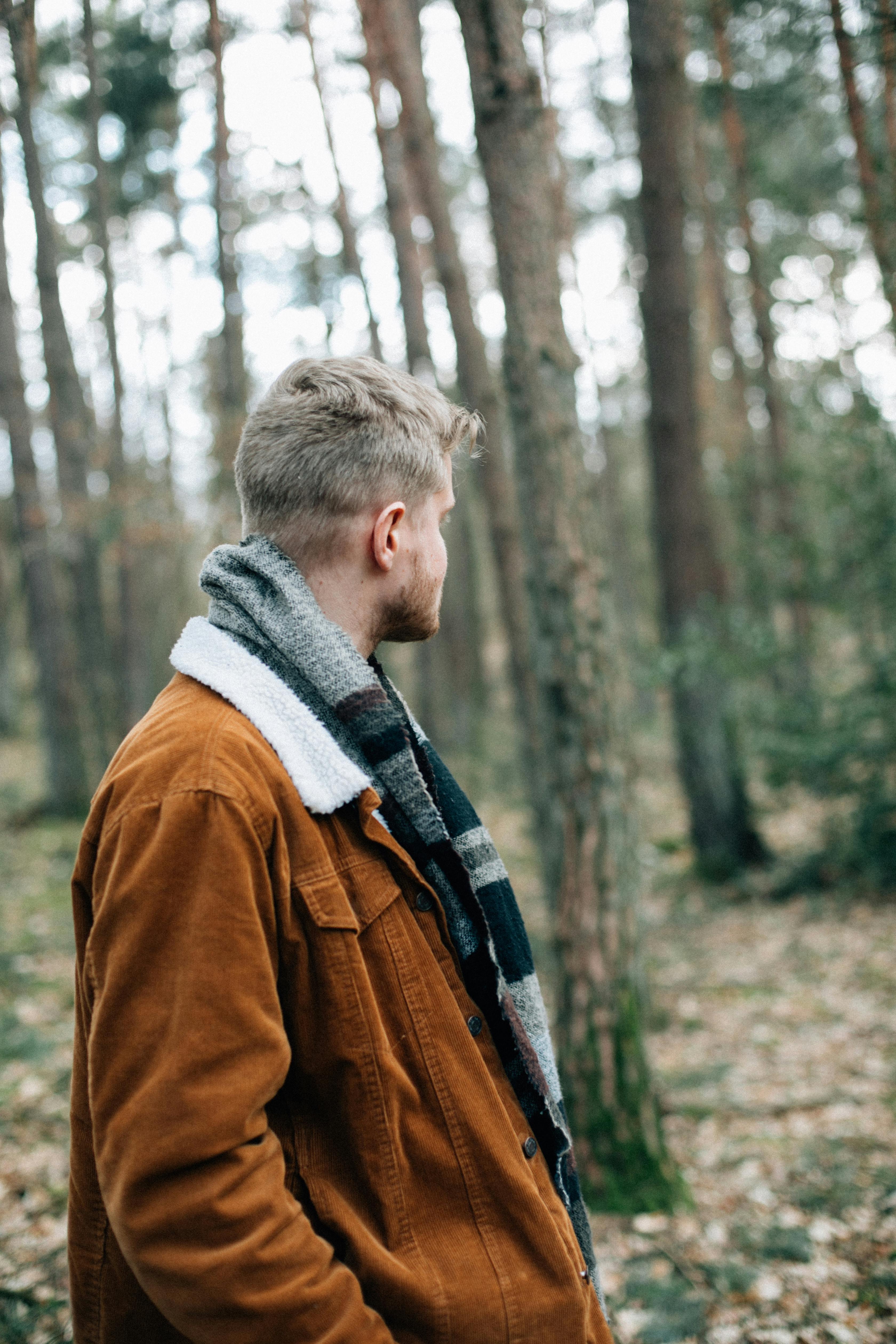 Man in Brown Jacket and Gray Muffler Holding a Newspaper · Free Stock Photo
