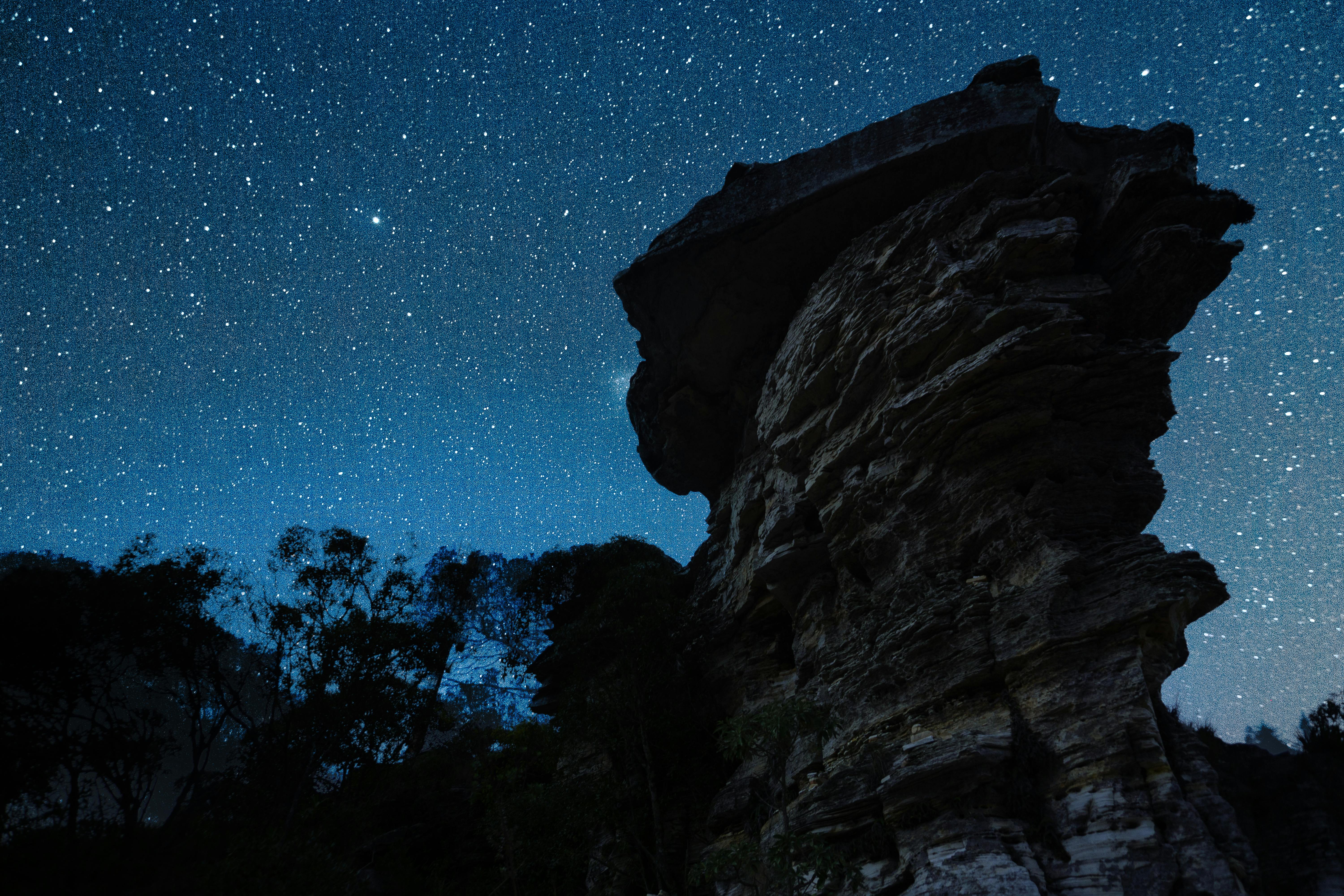 Graphite Rock Formation against Blue Sky with Stars · Free Stock Photo
