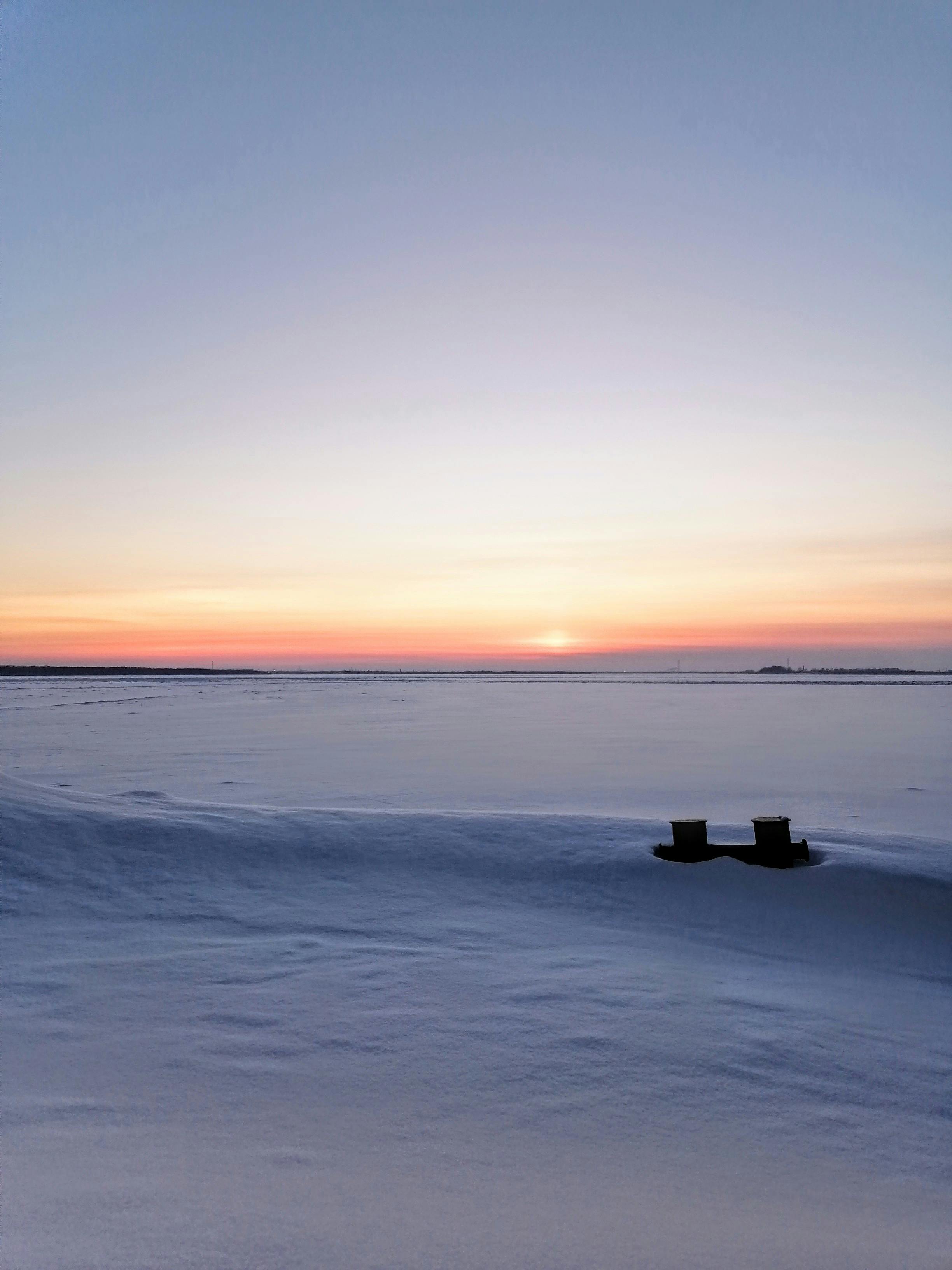 Flatland Covered in Snow at Sunset · Free Stock Photo