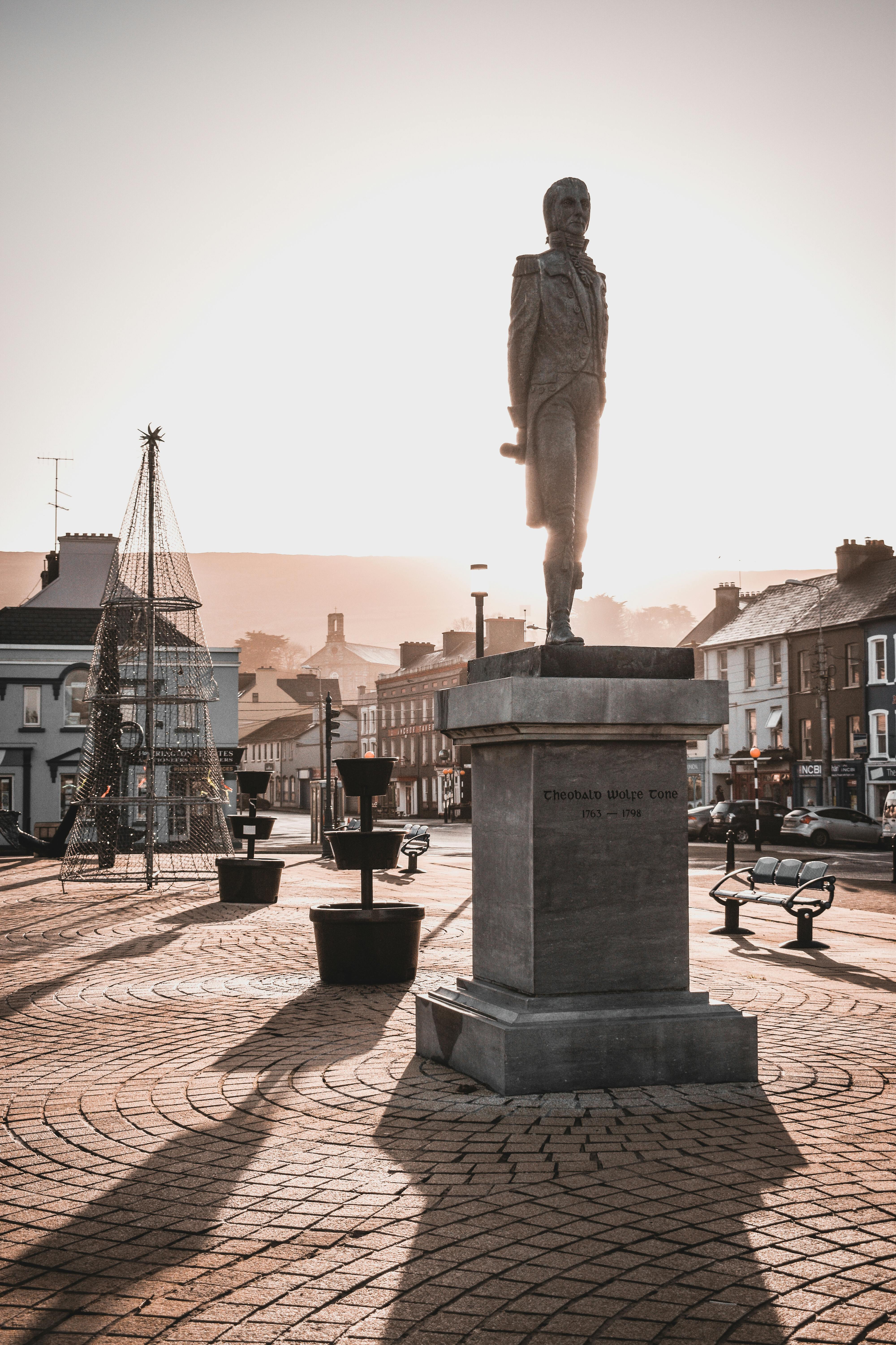 Golden Statues Beside a Window · Free Stock Photo