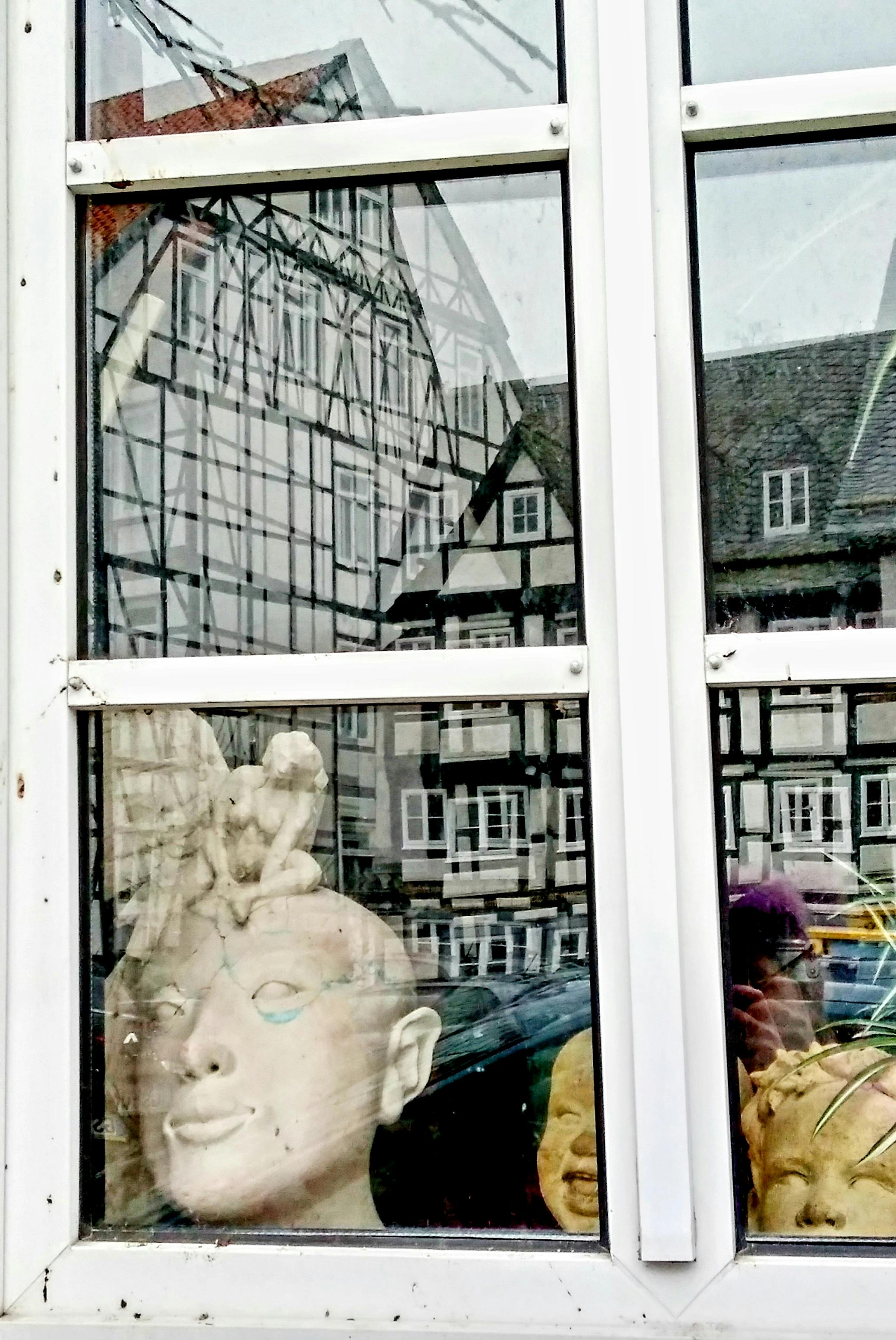 A White Framed Window with Sculptures · Free Stock Photo