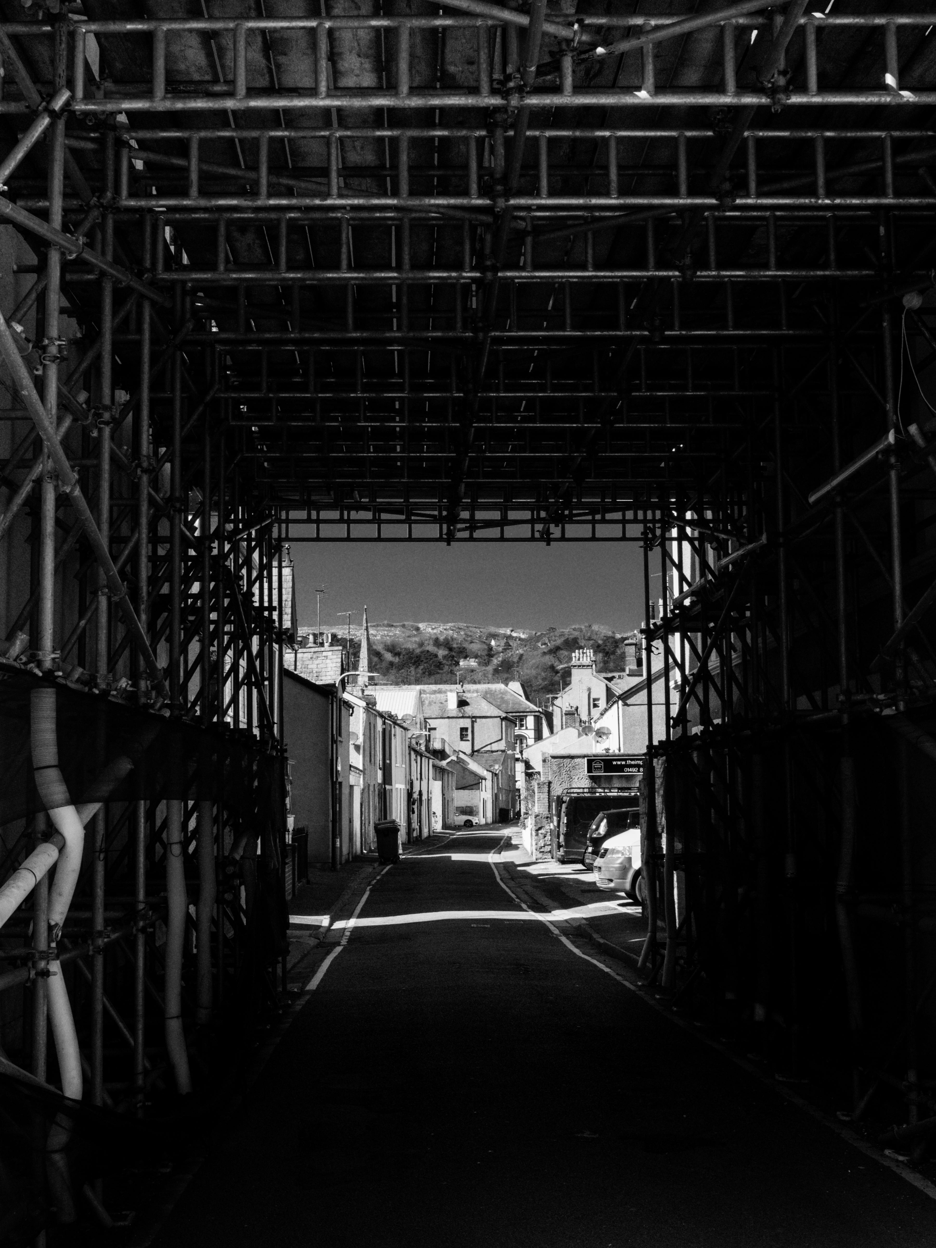 Grayscale Photo of a Steel Gate Locked with a Chain · Free Stock Photo