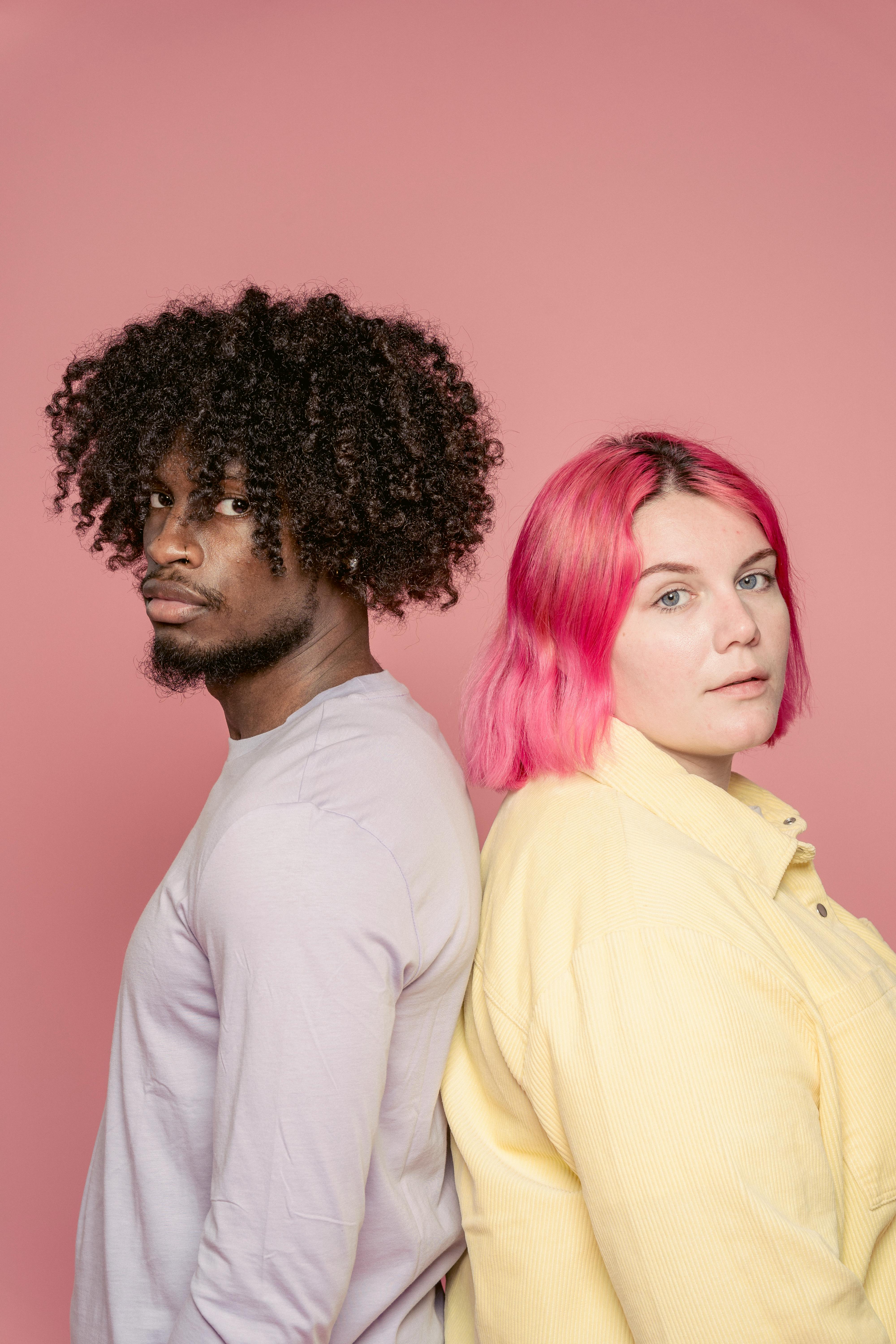 Multiracial models standing against pink background · Free Stock Photo