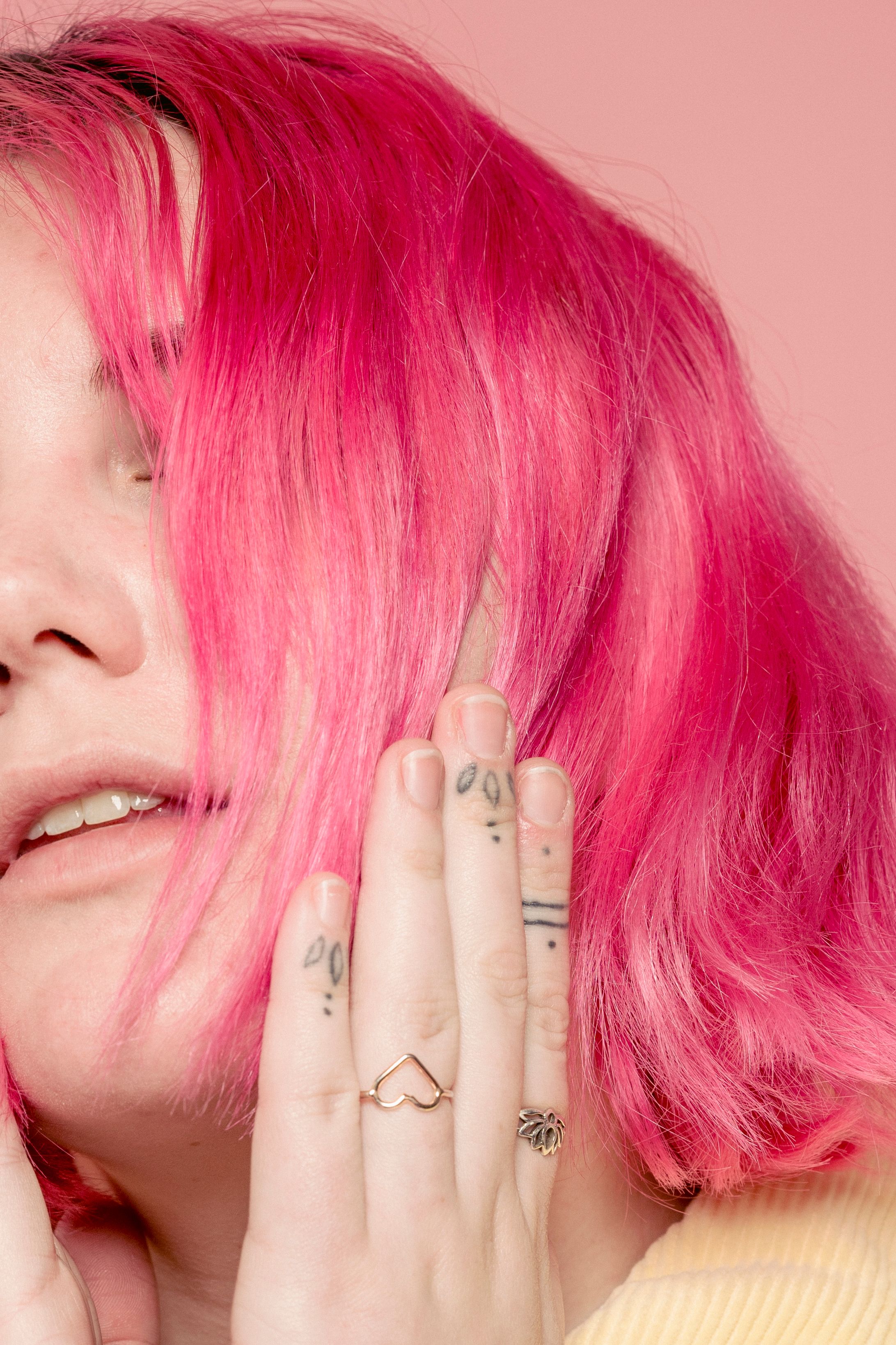 Gentle woman touching face with tattooed hands · Free Stock Photo