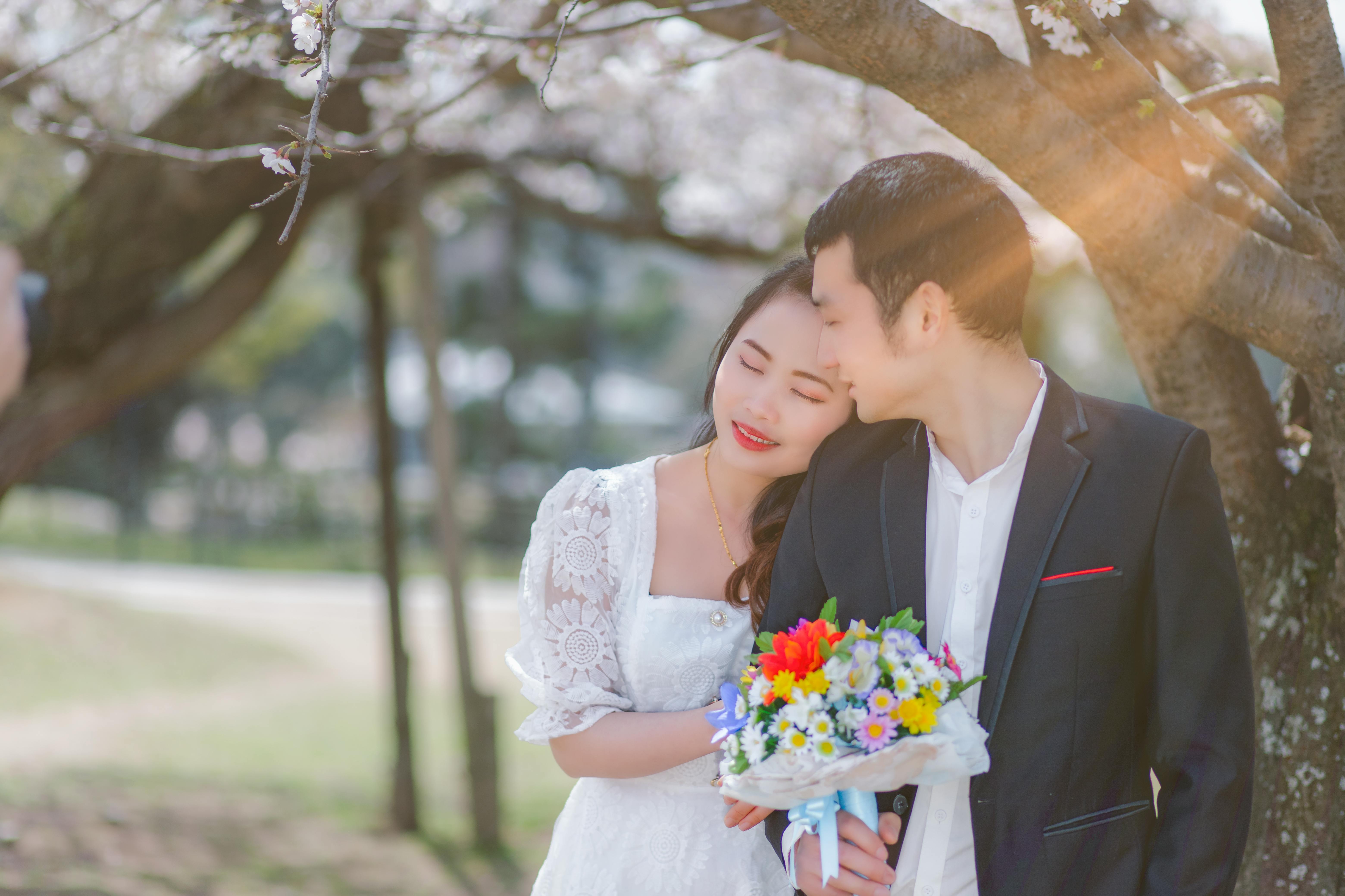 Content newlywed couple near ornamental fireplace in wedding hall ...
