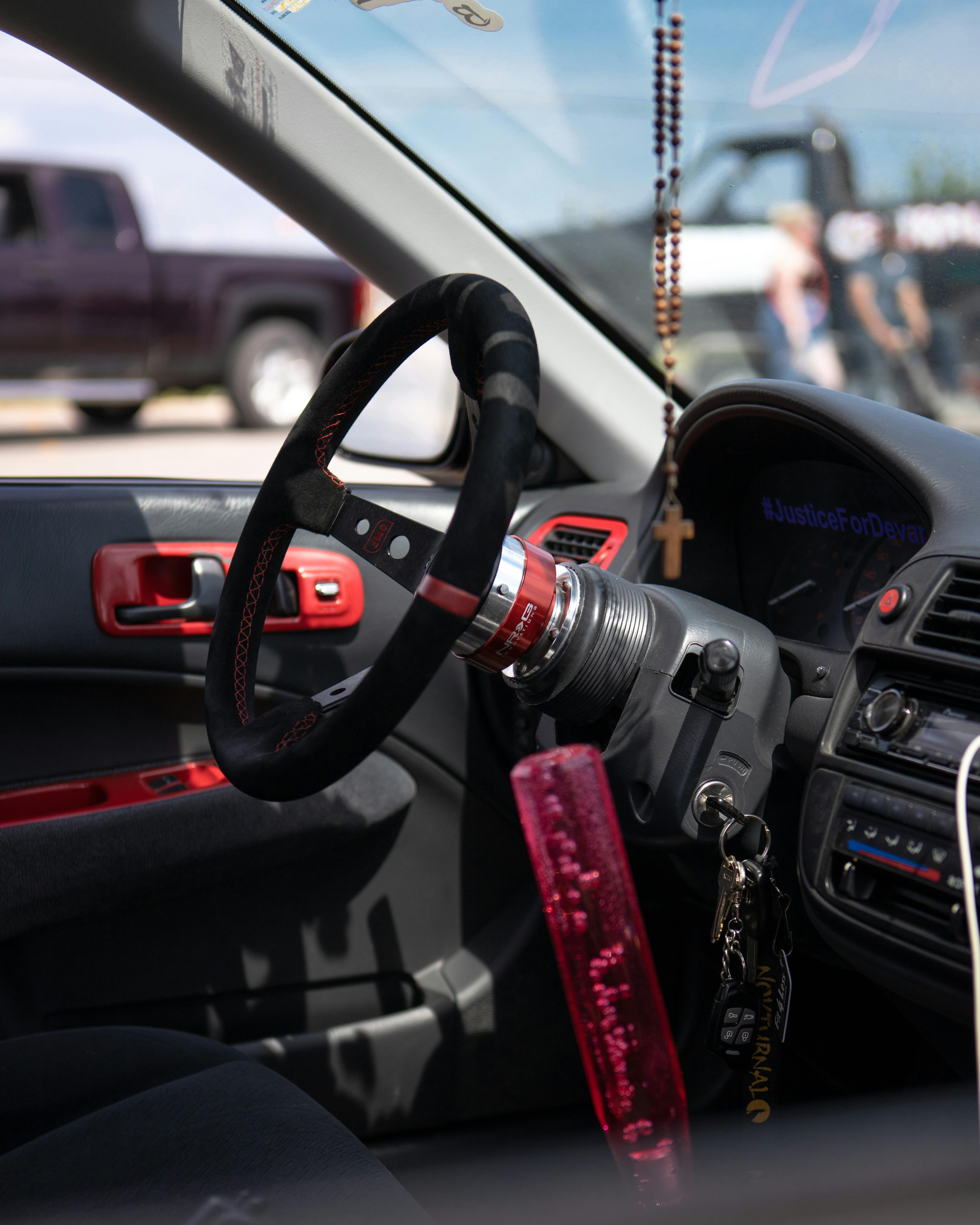 A Red and Black Steering Wheel · Free Stock Photo