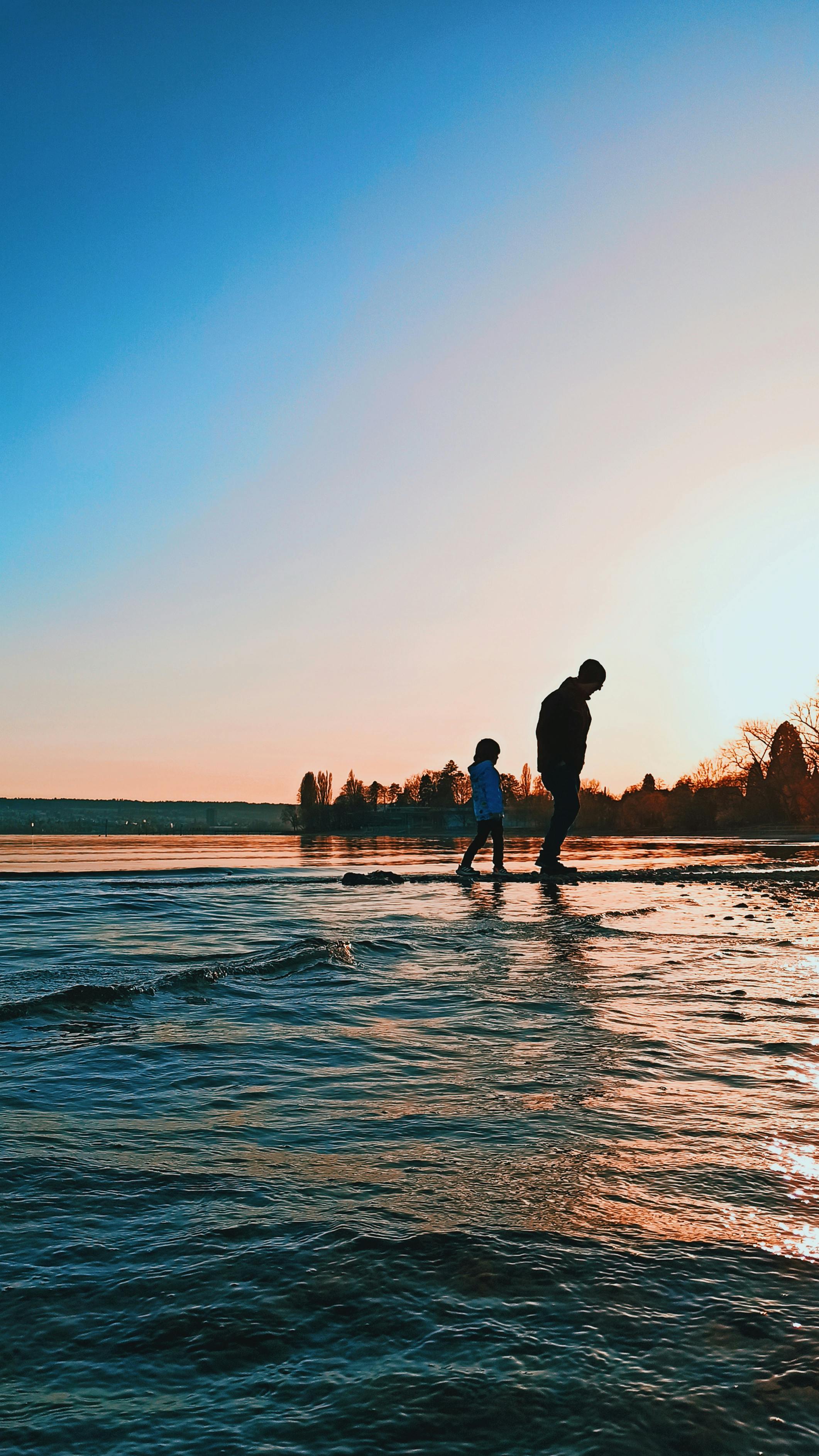 People Sitting beside River · Free Stock Photo