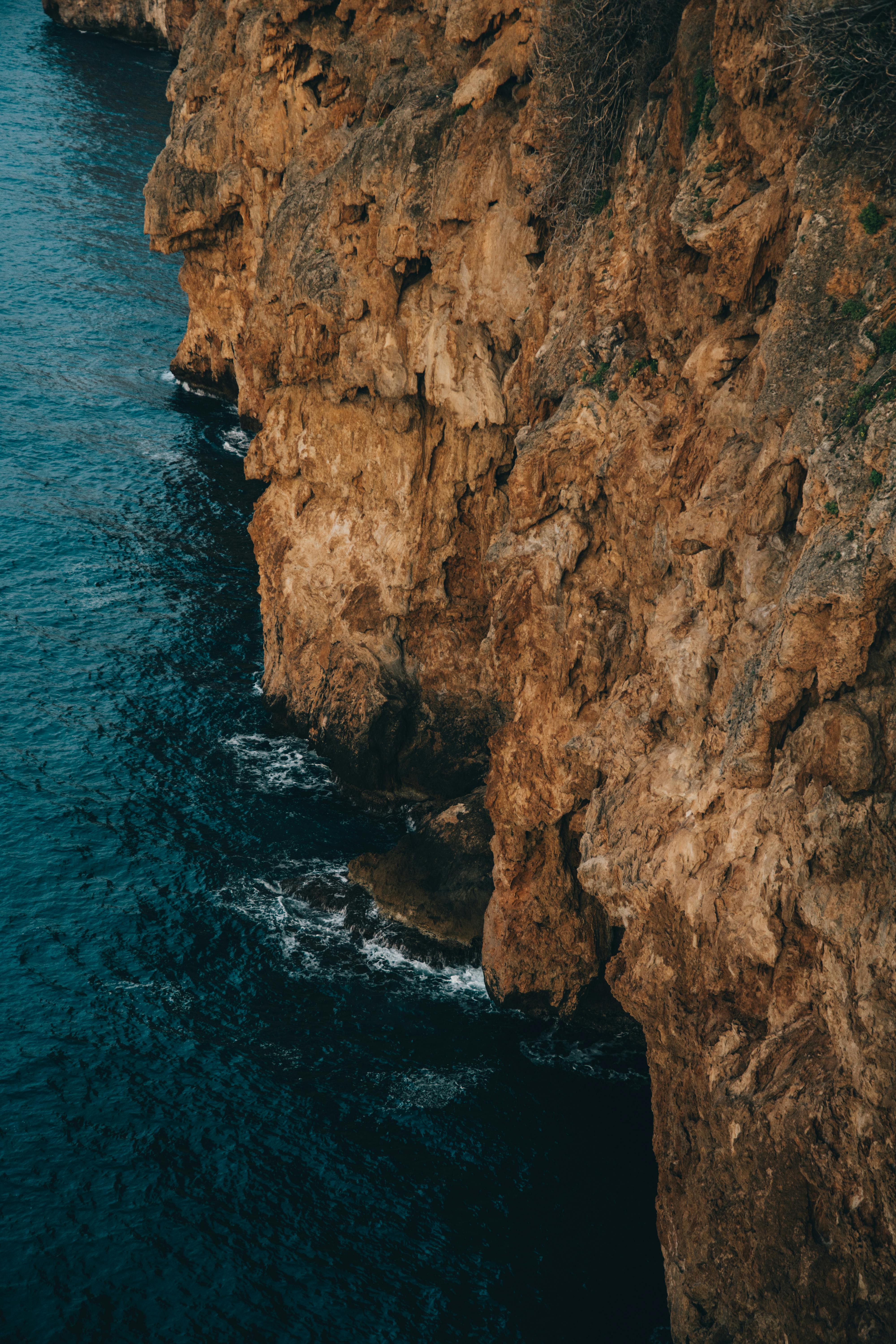 Cliff of a Coastal Mountain Above Sea · Free Stock Photo