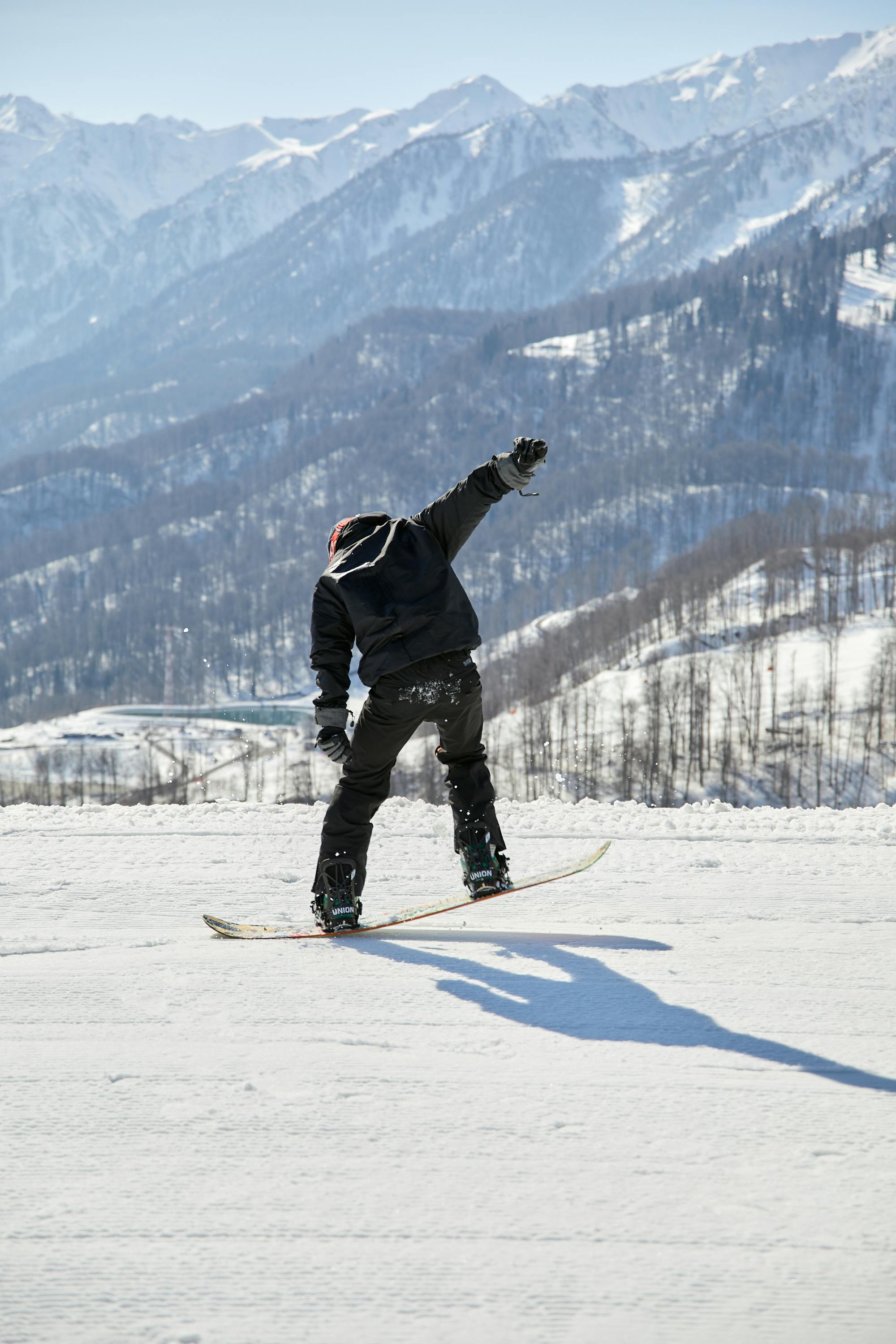 Man in Black Snowboard With Binding Performs a Jump · Free Stock Photo