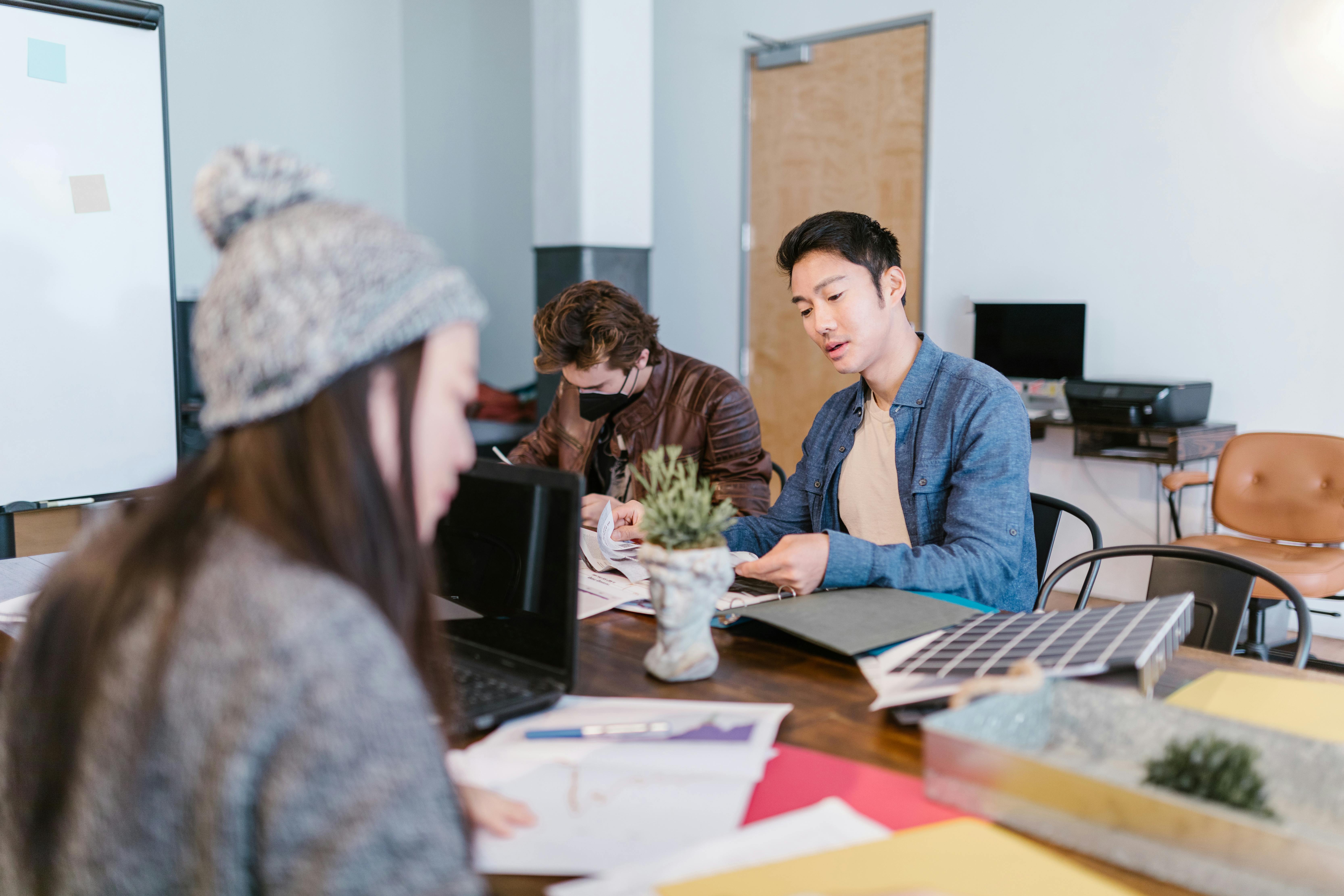 People Eating while Looking at the Documents · Free Stock Photo