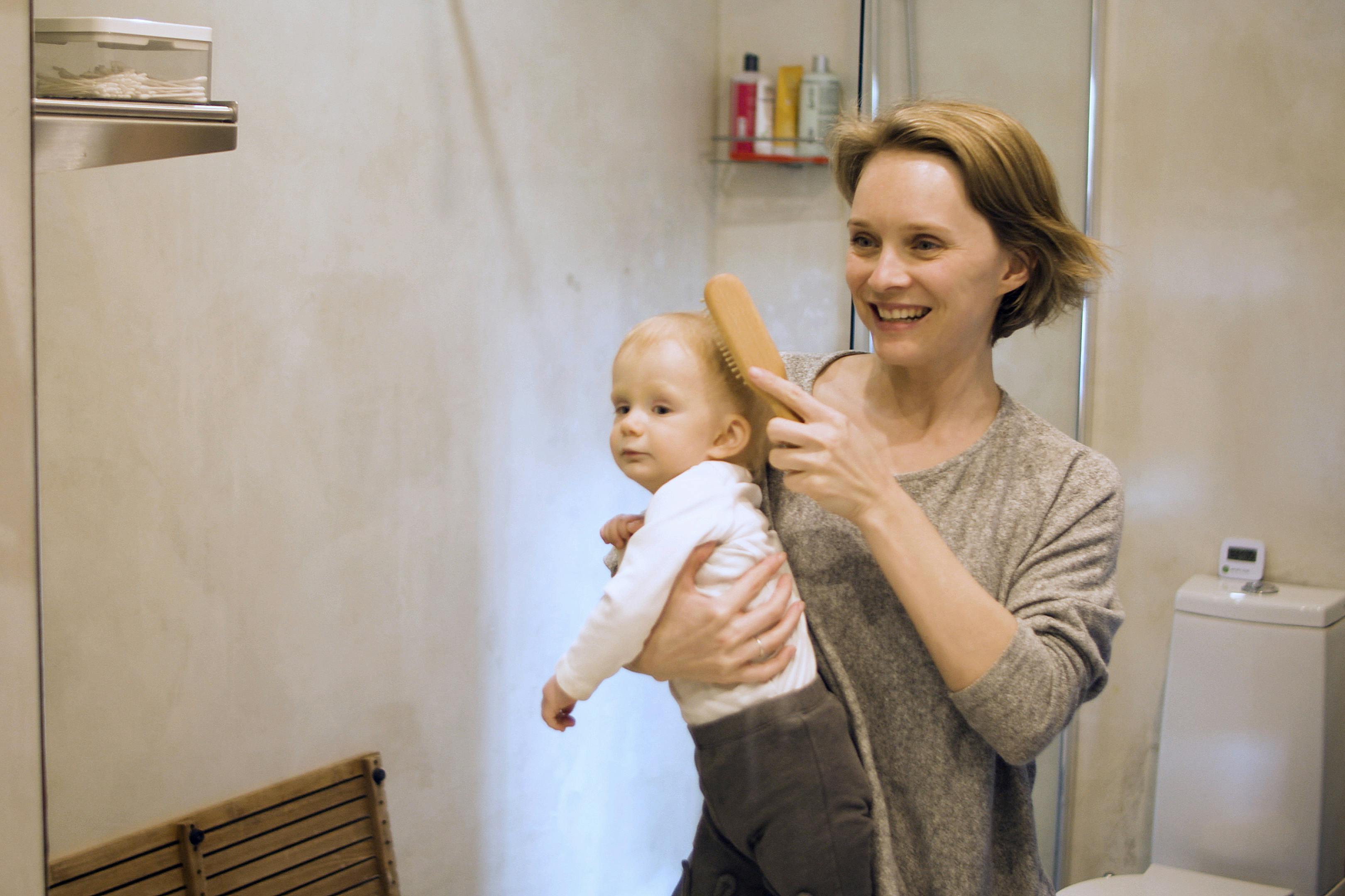 Caring mother drying child with towel in bathroom · Free Stock Photo