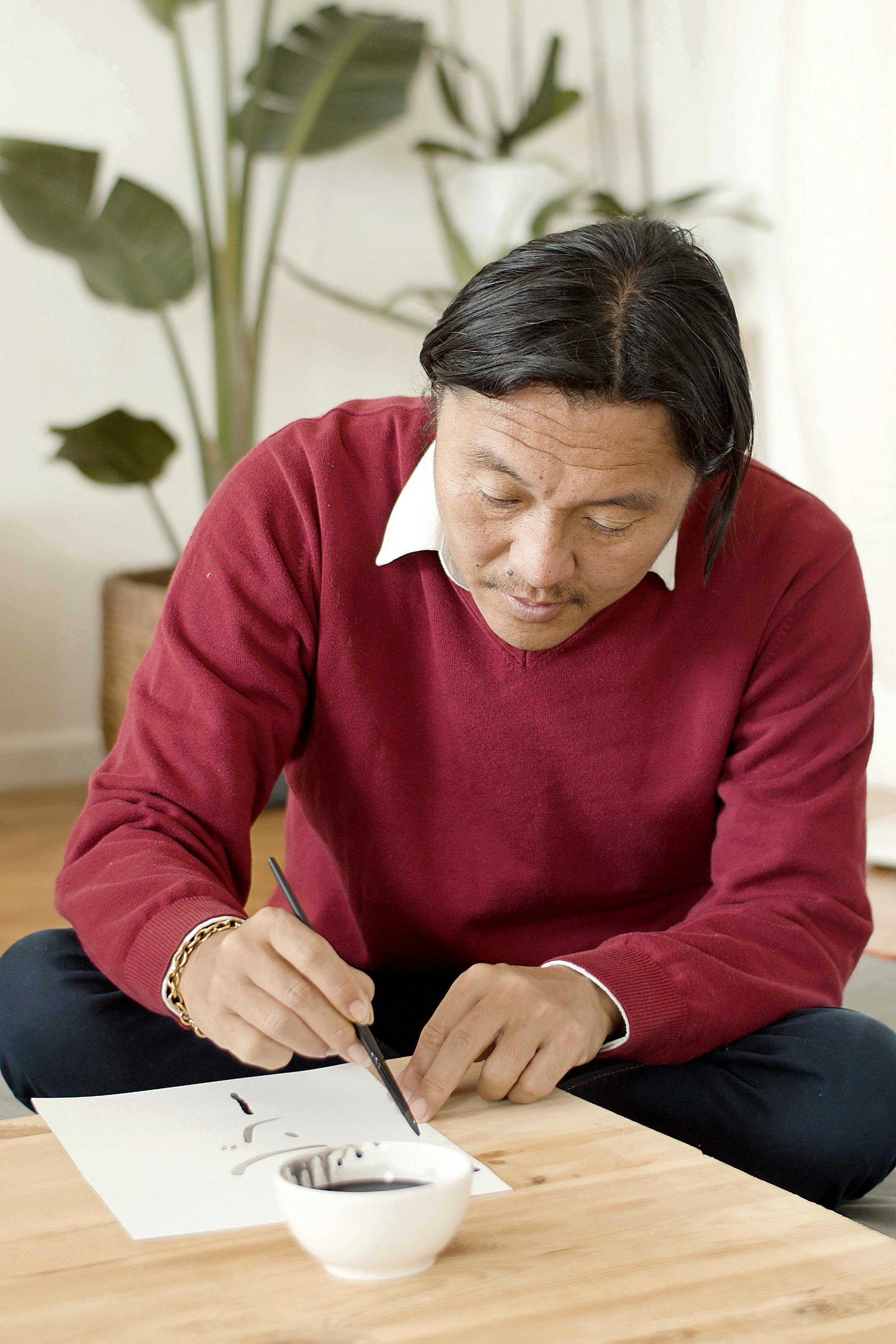 A Woman in Red Sweater Painting on White Paper · Free Stock Photo