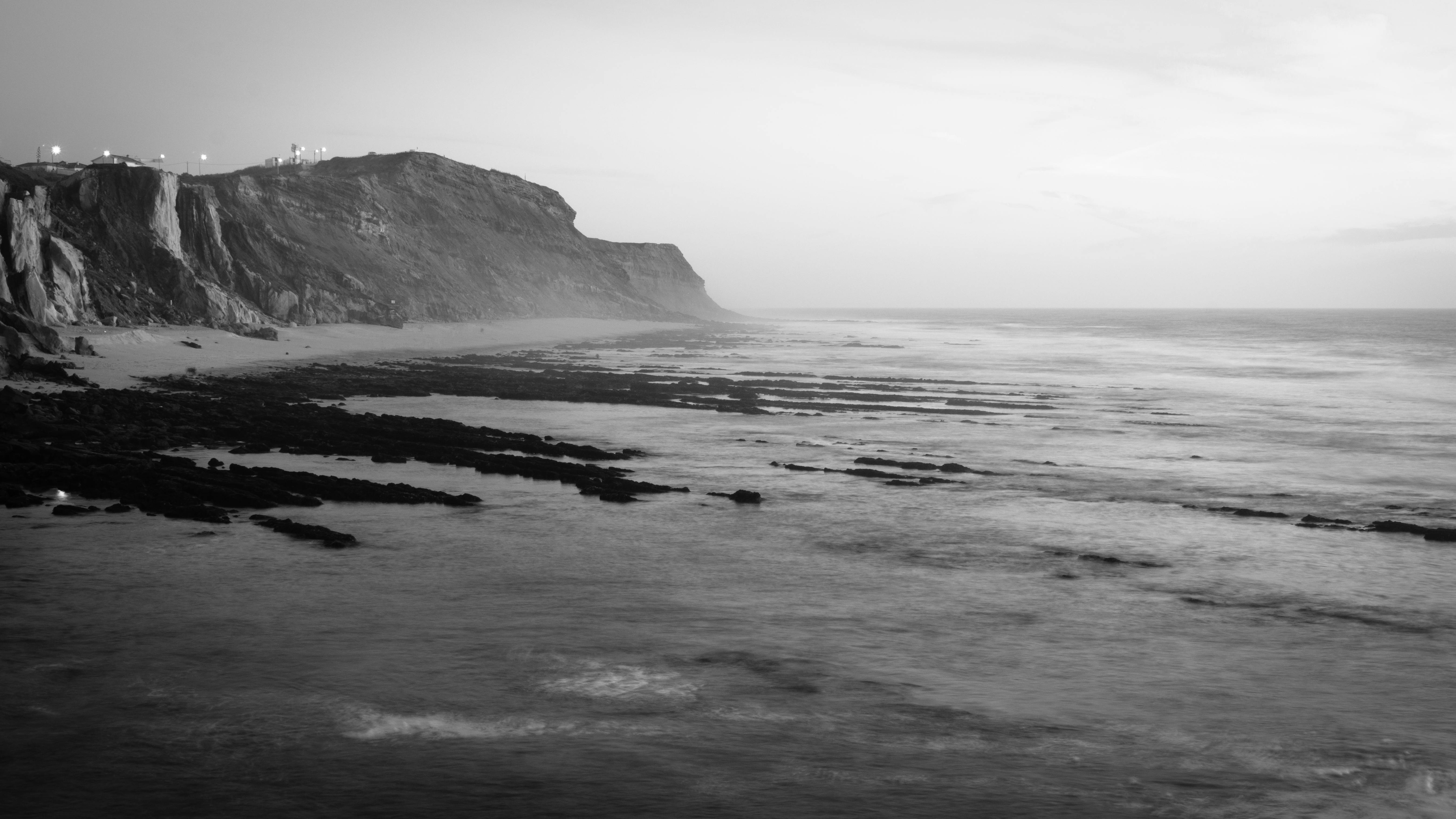 Grayscale Photo of a Coastal Cliff · Free Stock Photo