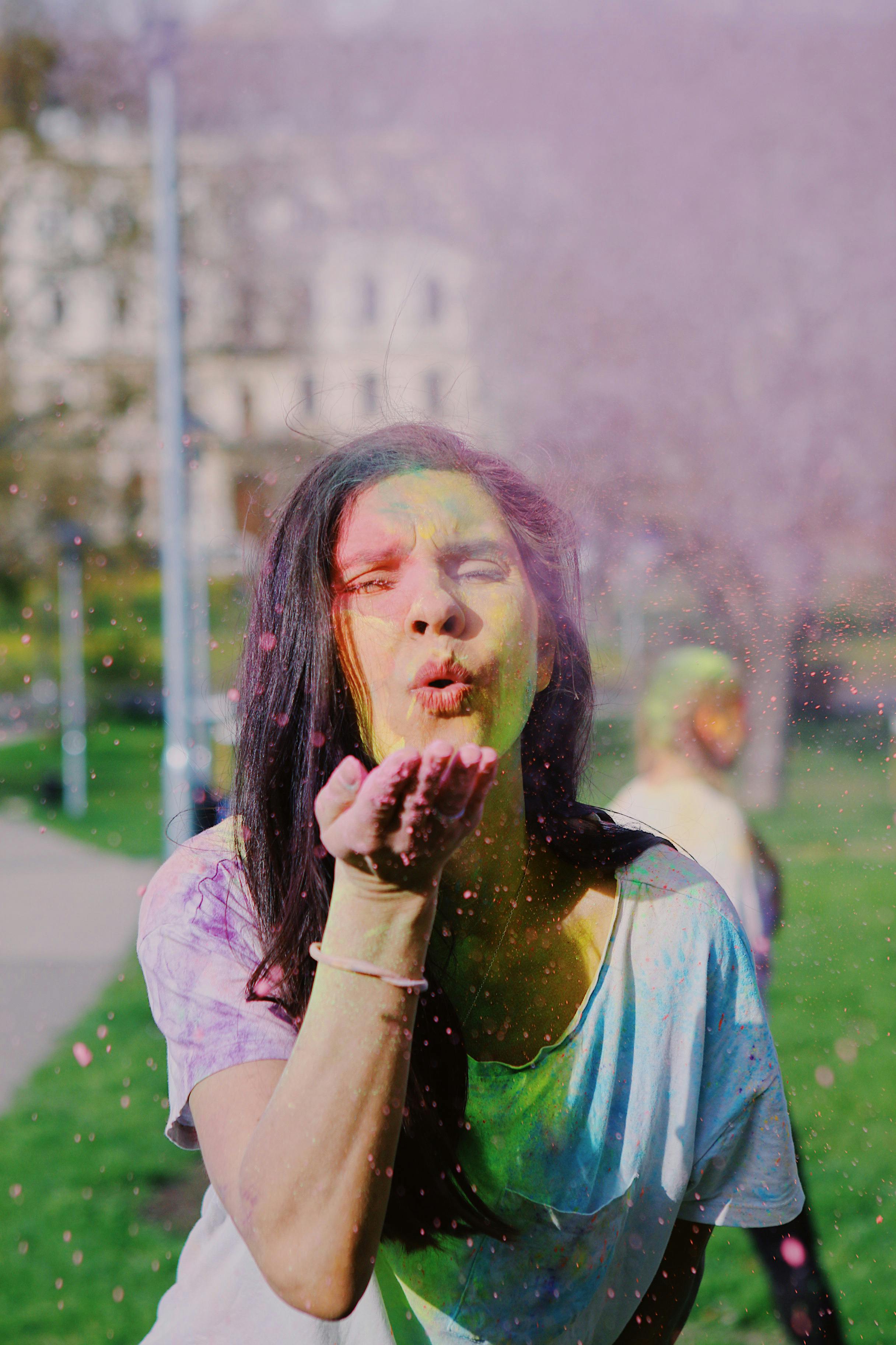 Woman Blowing Holi Powder from Her Hand · Free Stock Photo
