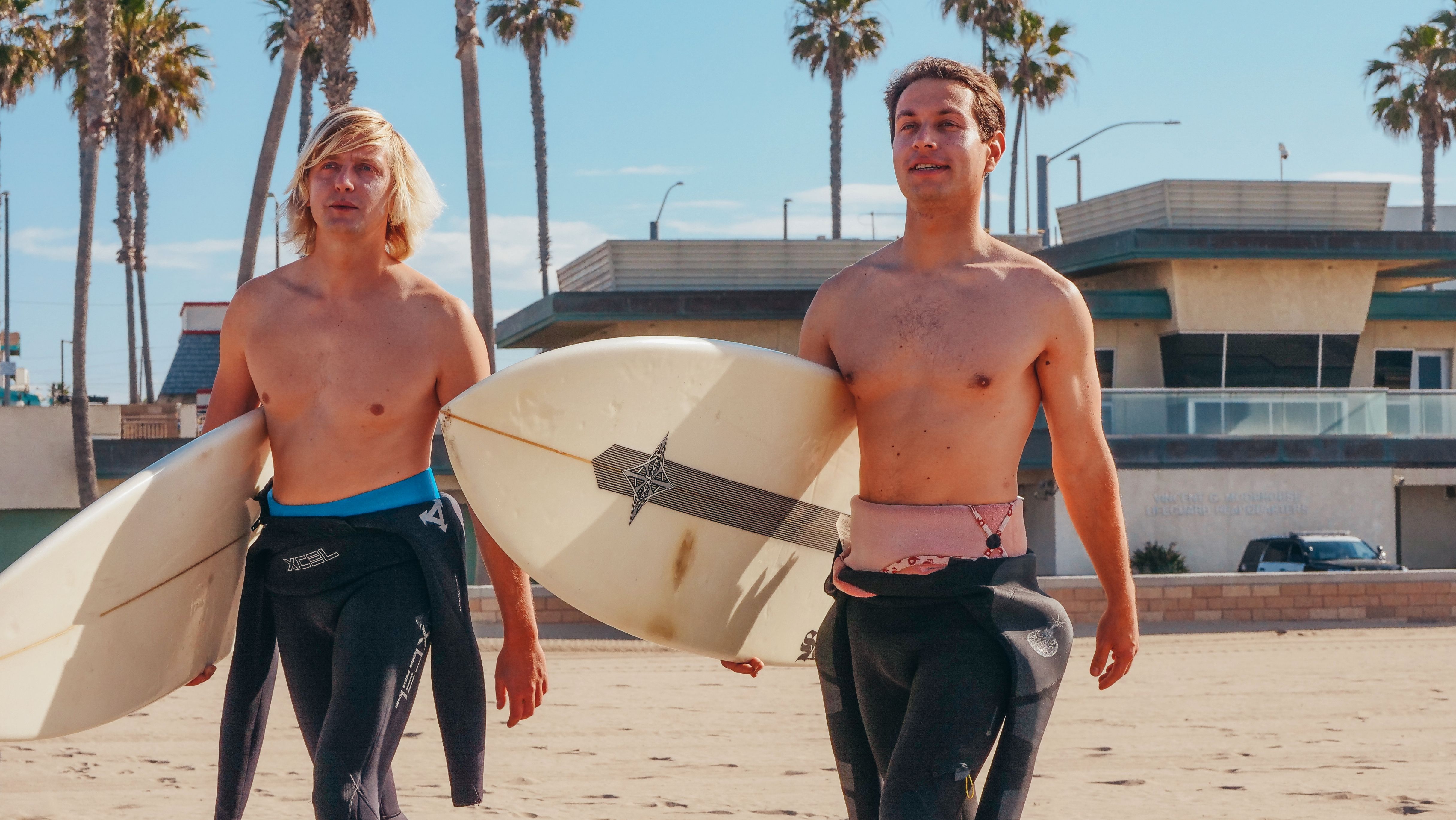 Photo of Shirtless Men Holding a Fish Trap · Free Stock Photo