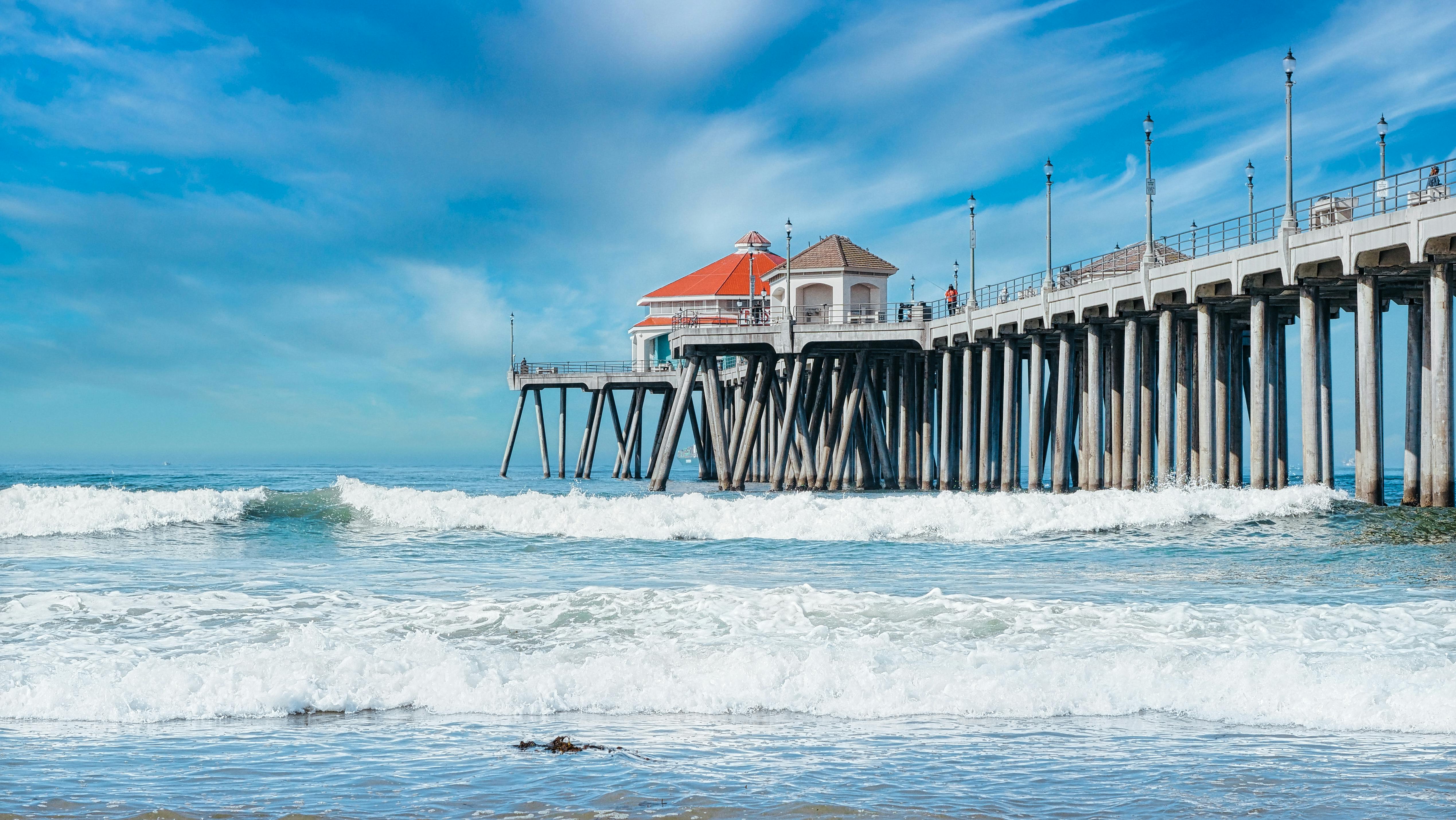 A Scenic View of a Pier on the Beach · Free Stock Photo
