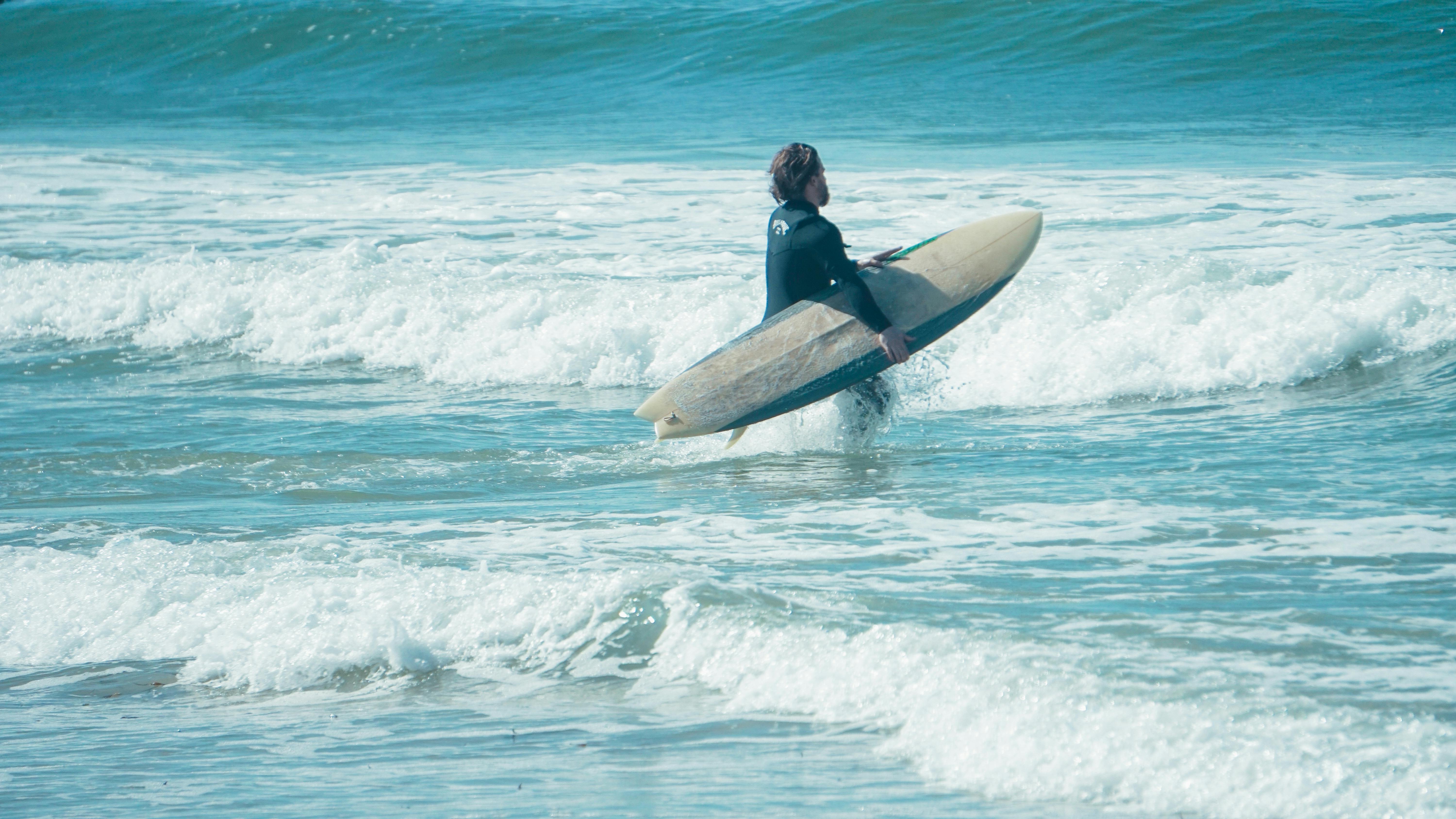 A Surfer Running Towards the Sea · Free Stock Photo
