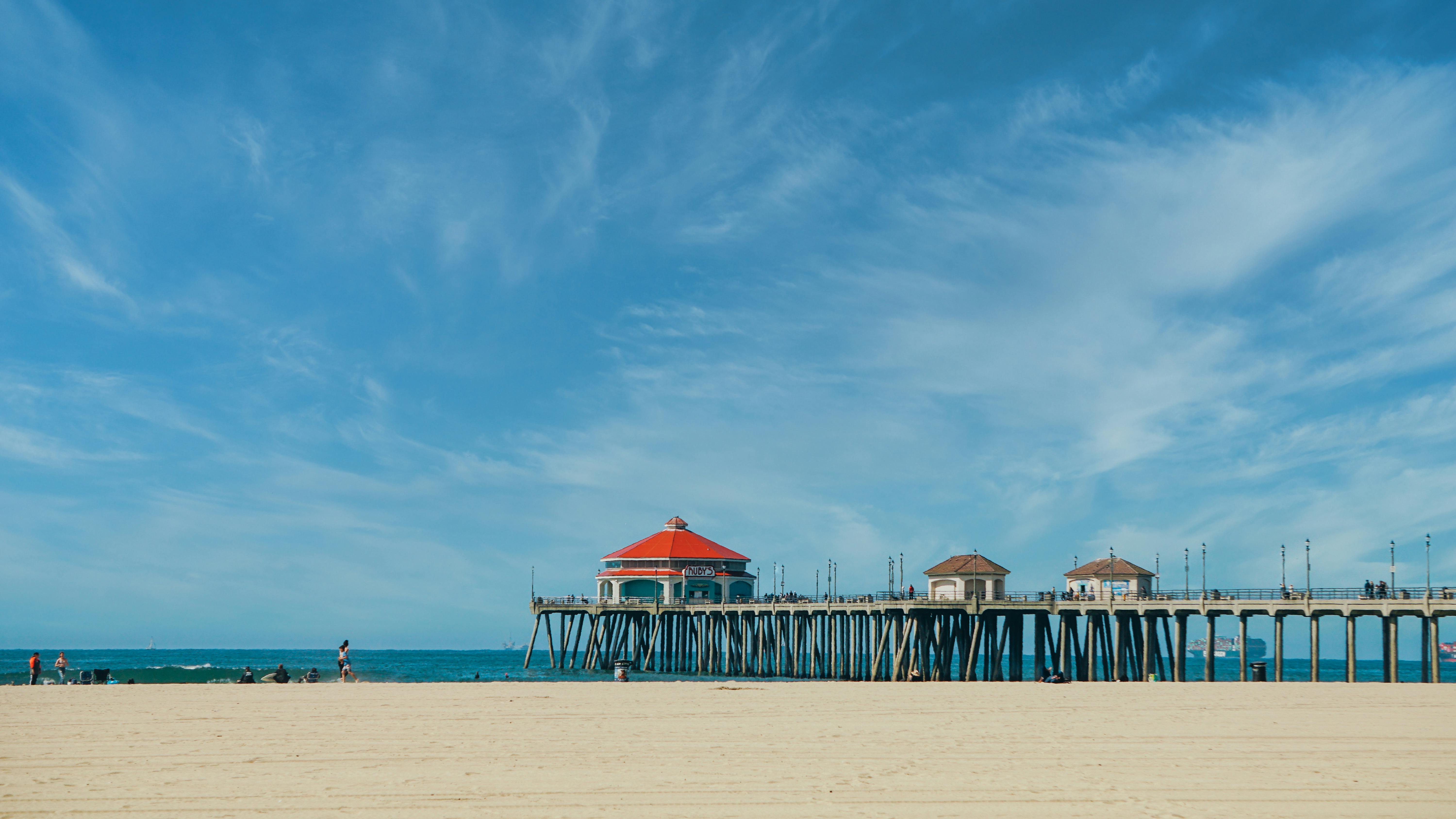 A Scenic View of a Pier on the Beach · Free Stock Photo