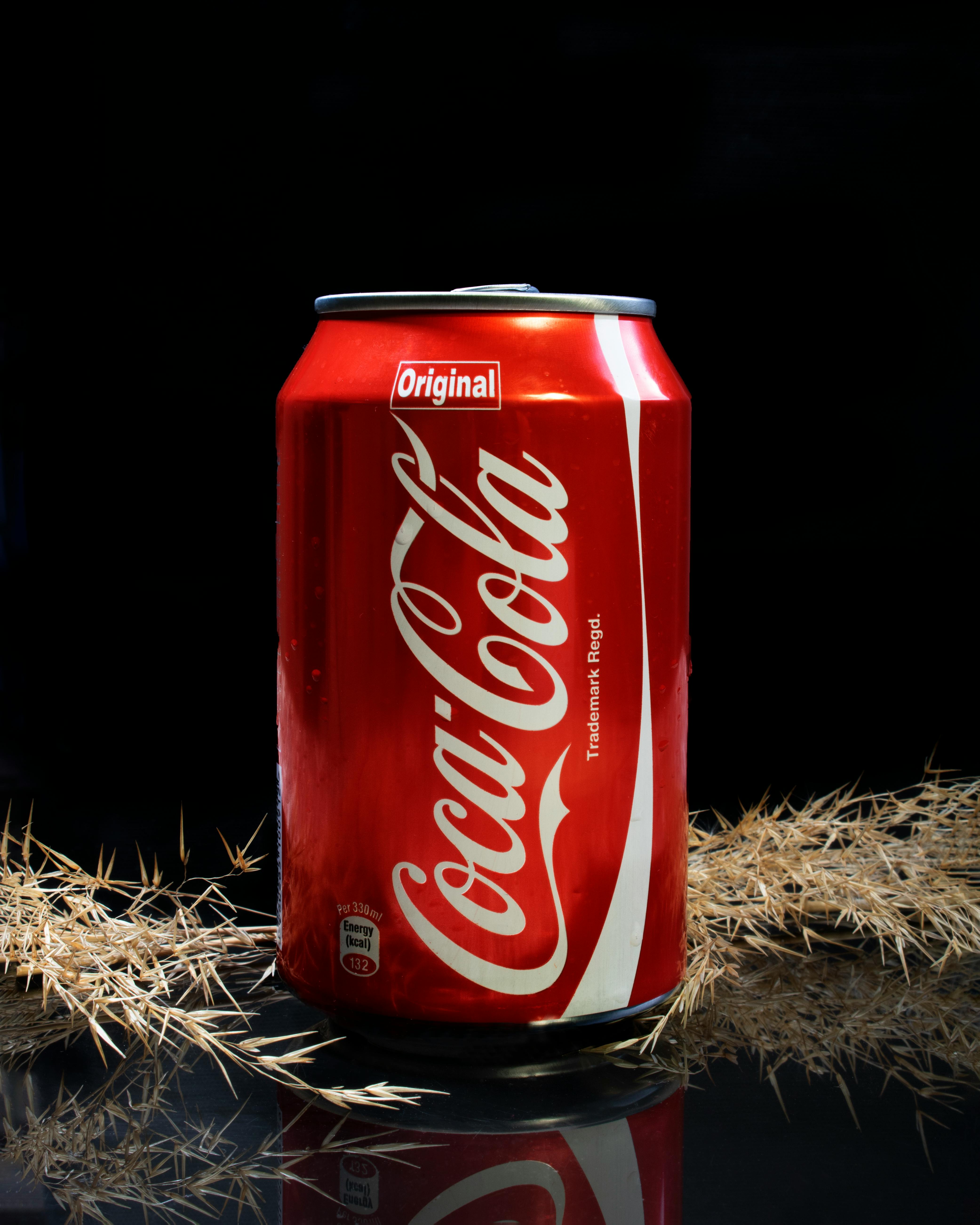 Coca-cola Can on Brown Concrete Surface · Free Stock Photo