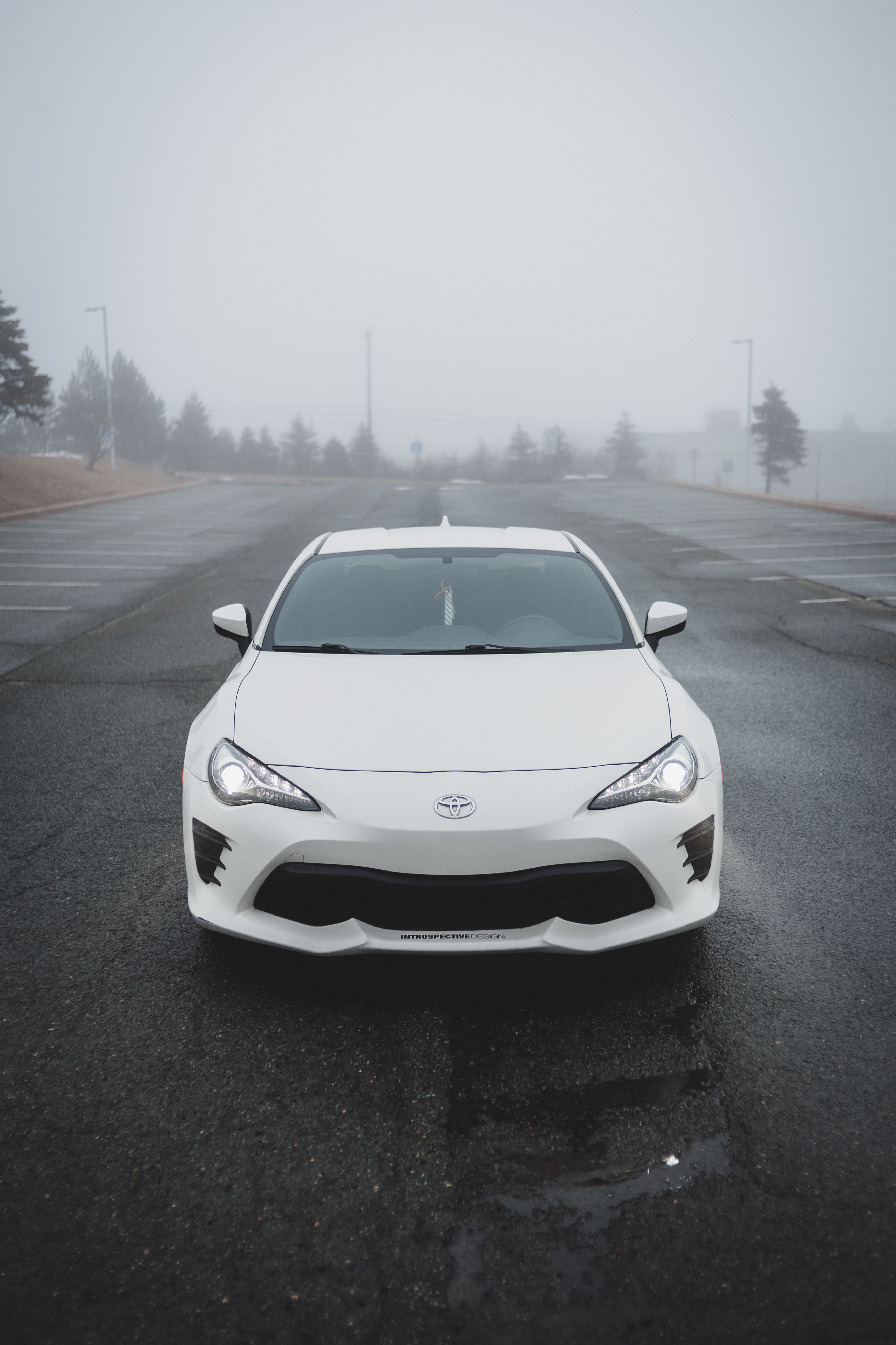 Modern sports car driving through countryside · Free Stock Photo