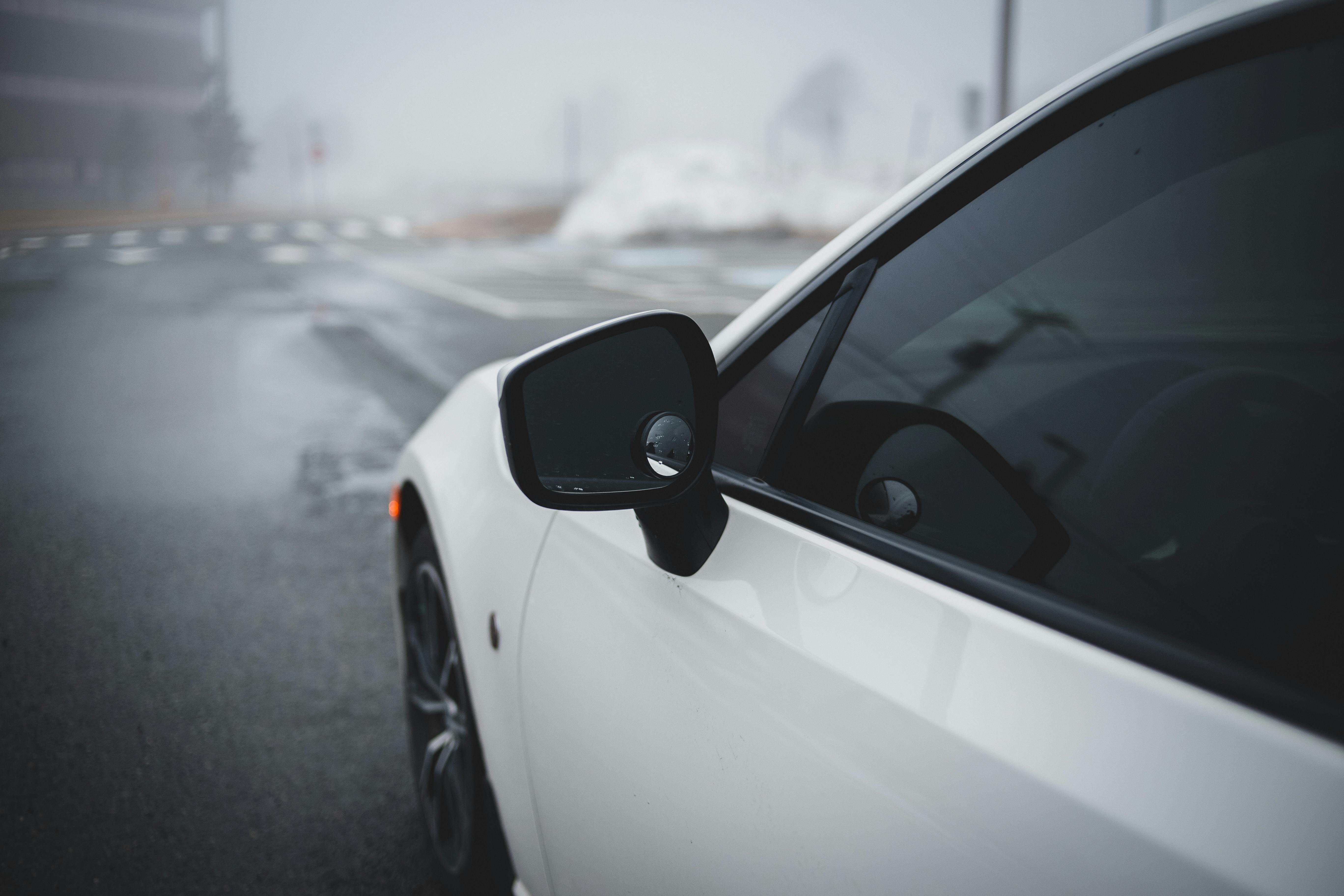 Reflection in side mirror of car driving on bridge · Free Stock Photo