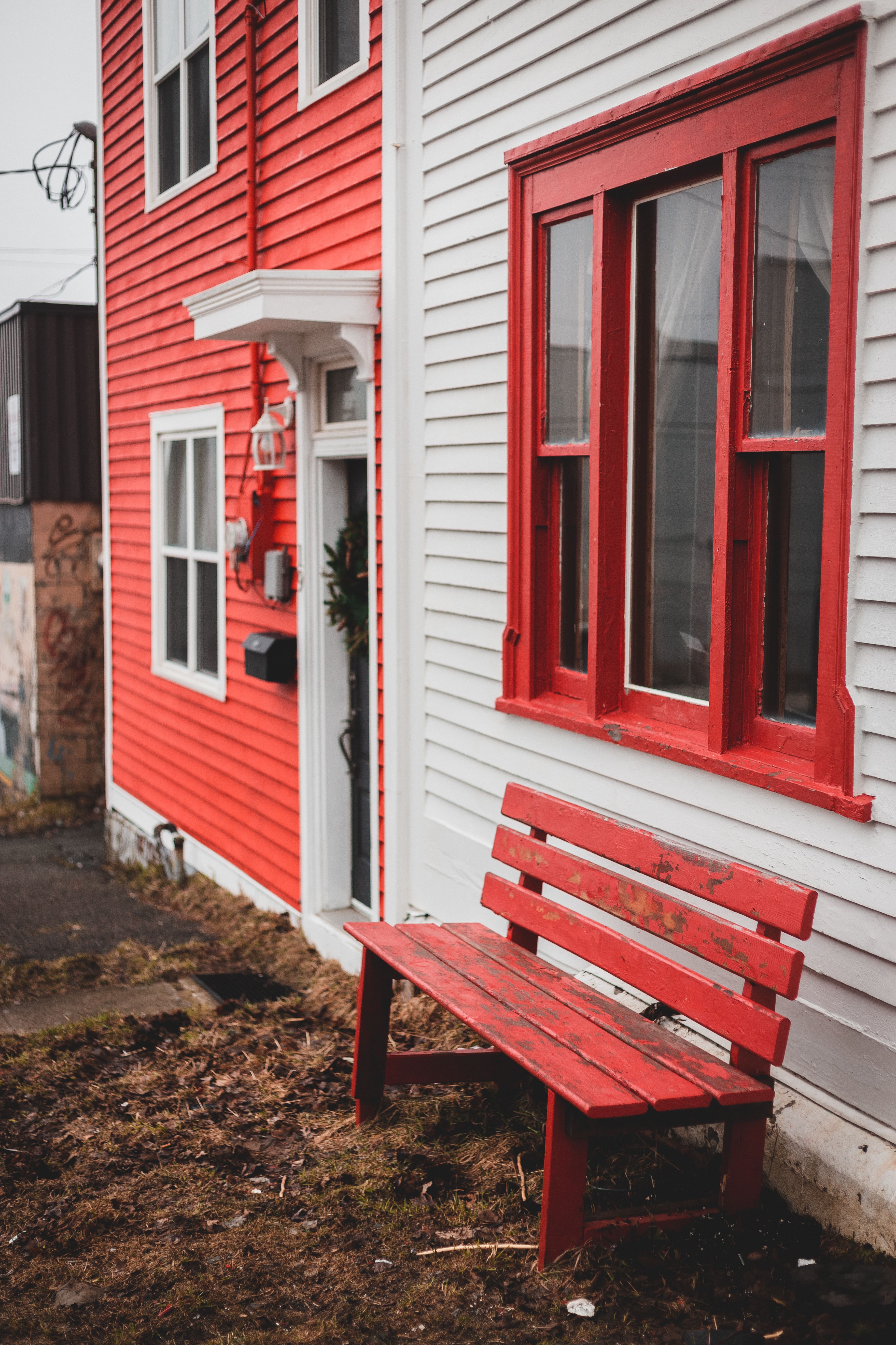 Wooden bench near colorful house · Free Stock Photo