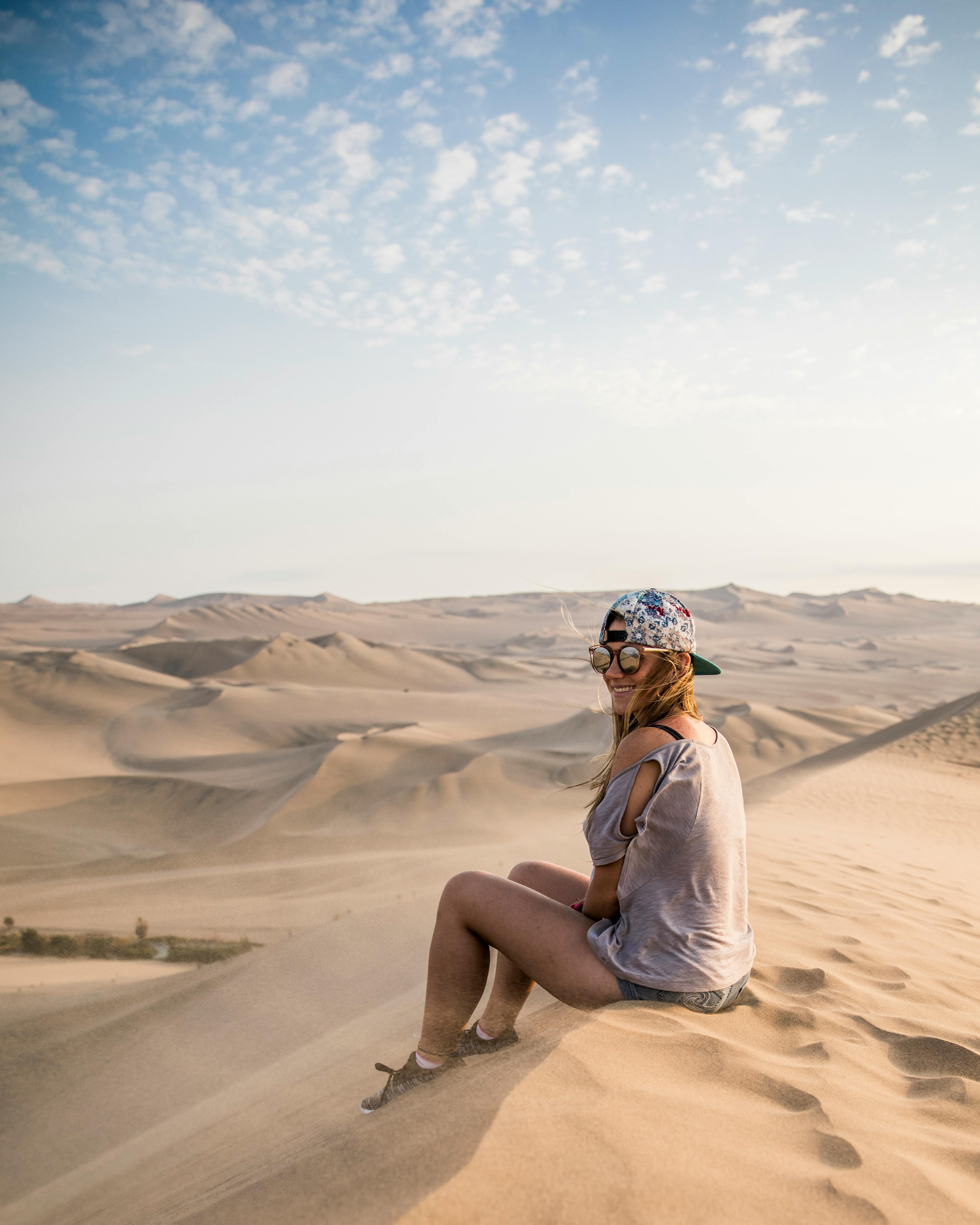 A Woman Sitting on the Desert · Free Stock Photo
