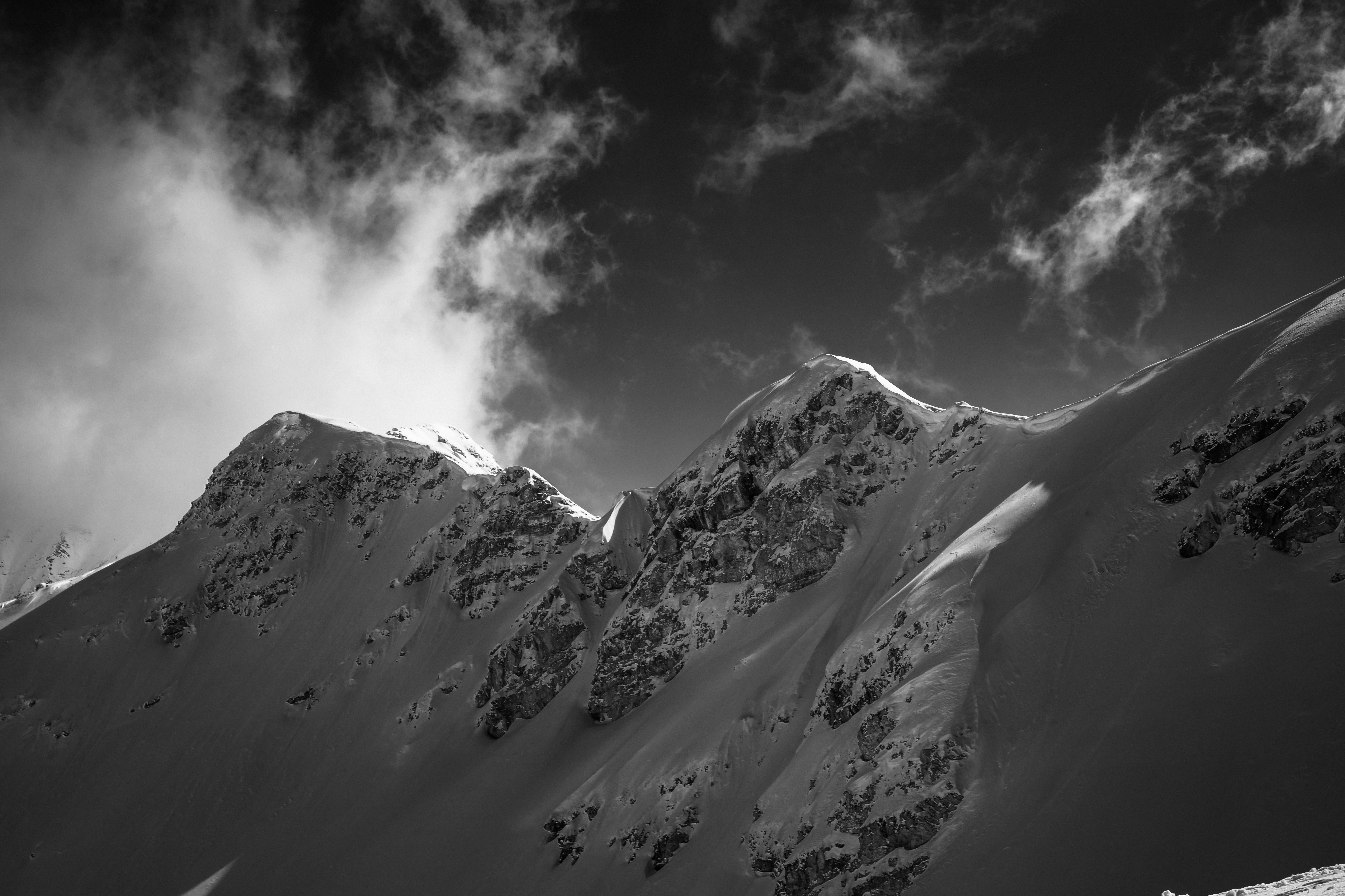 Grayscale Photo of a Snow-Covered Mountain · Free Stock Photo
