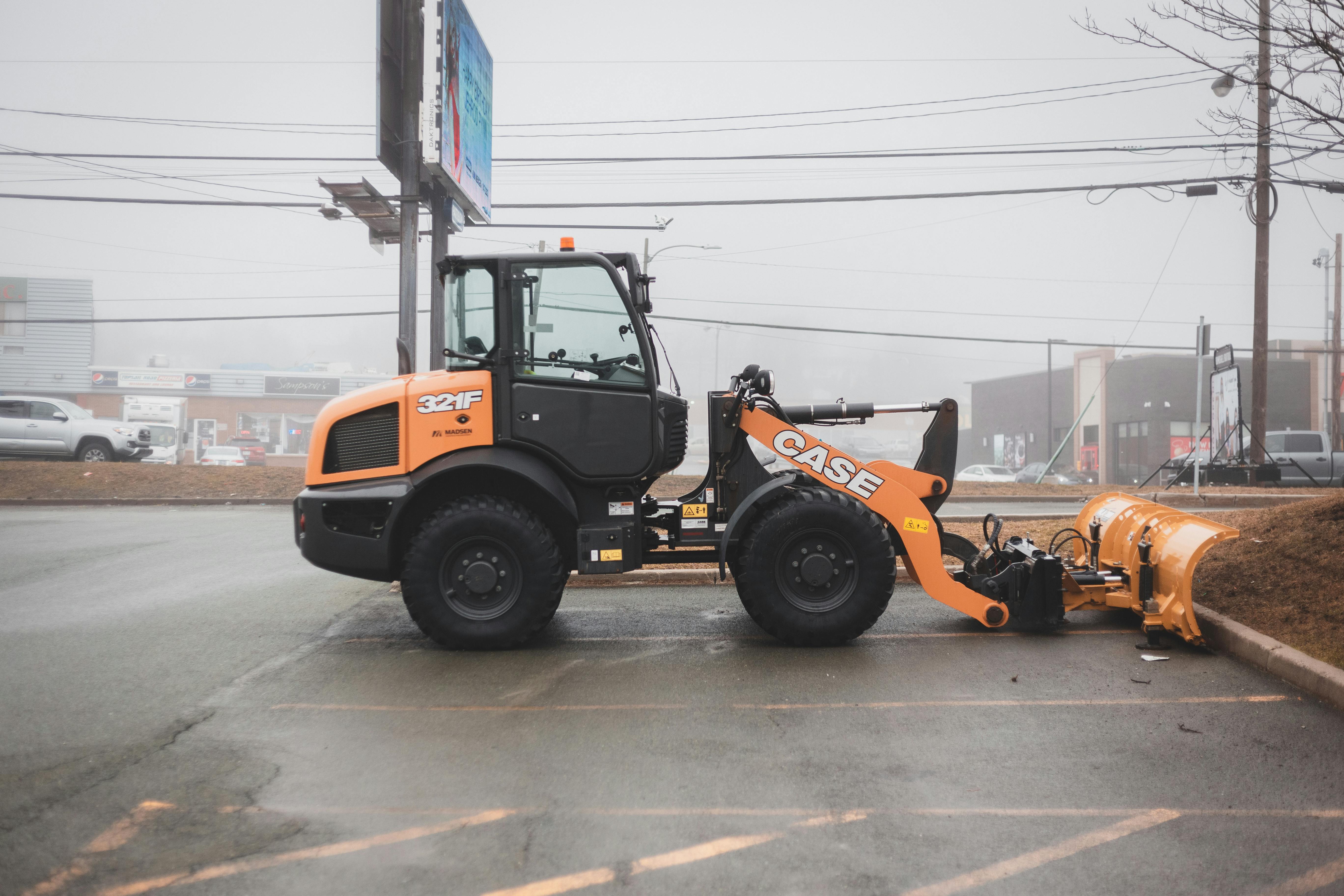 Modern tractor parked on asphalt road on street · Free Stock Photo