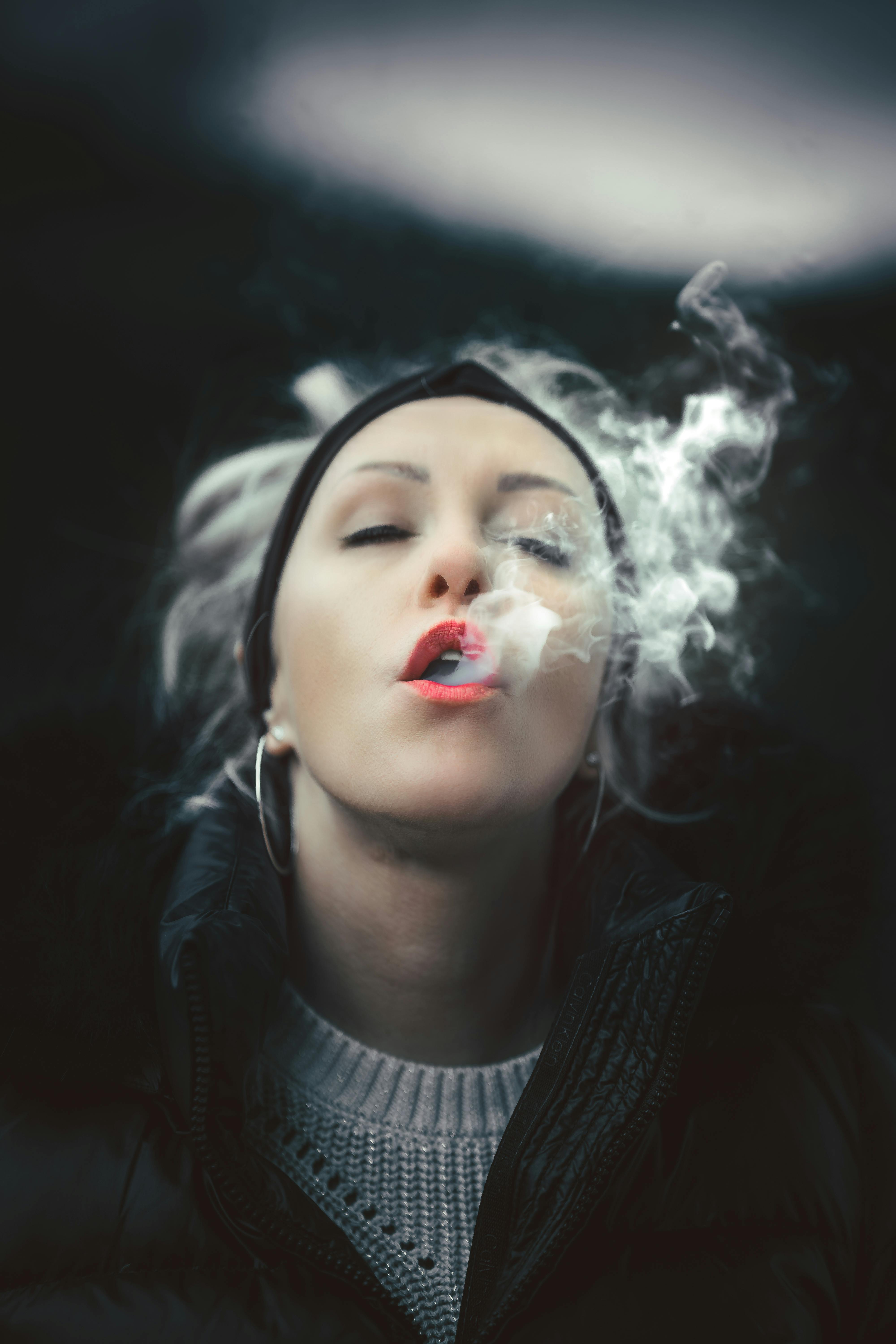 A Woman Blowing Smoke · Free Stock Photo