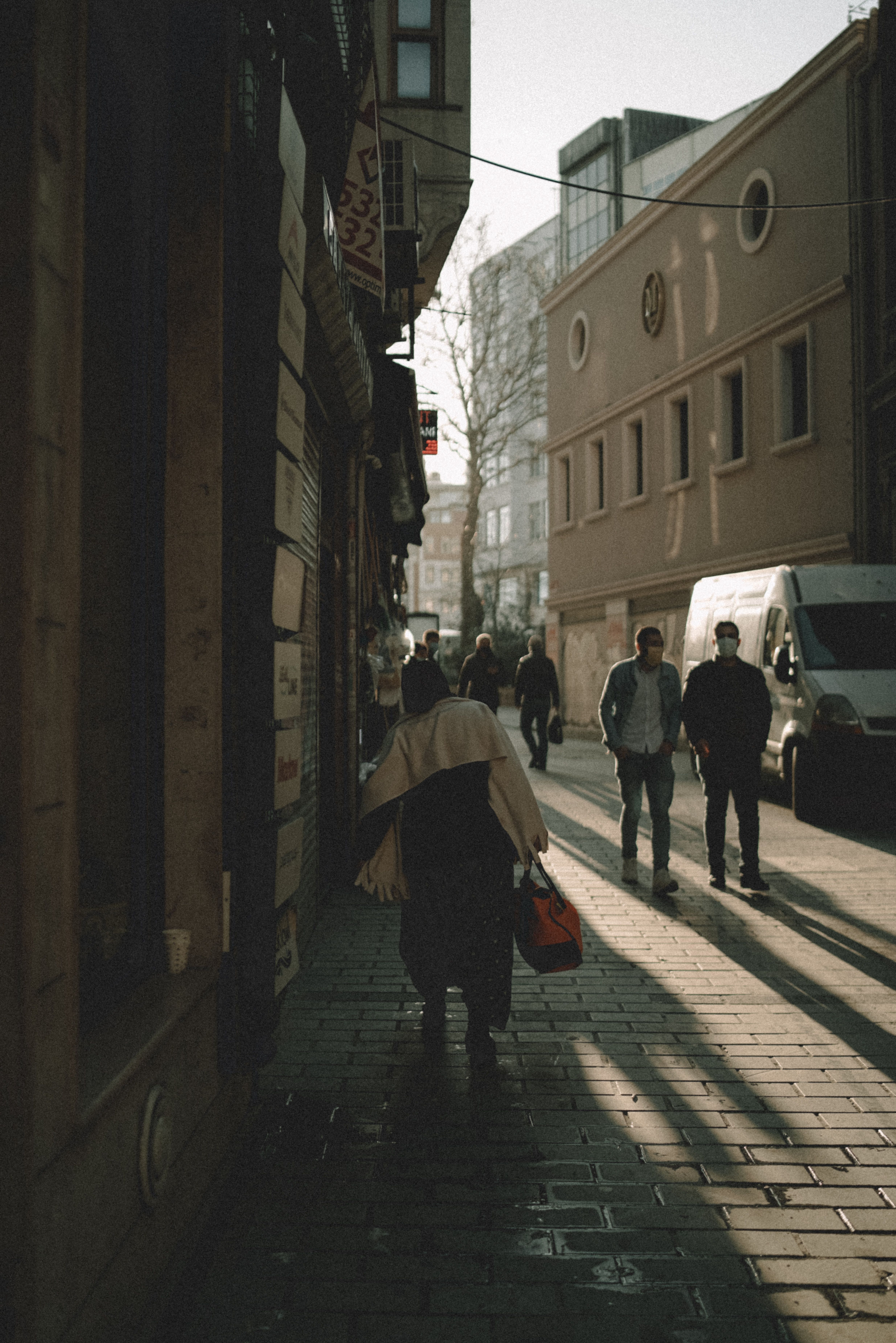 People Walking on the Street between Brown Concrete Buildings · Free ...