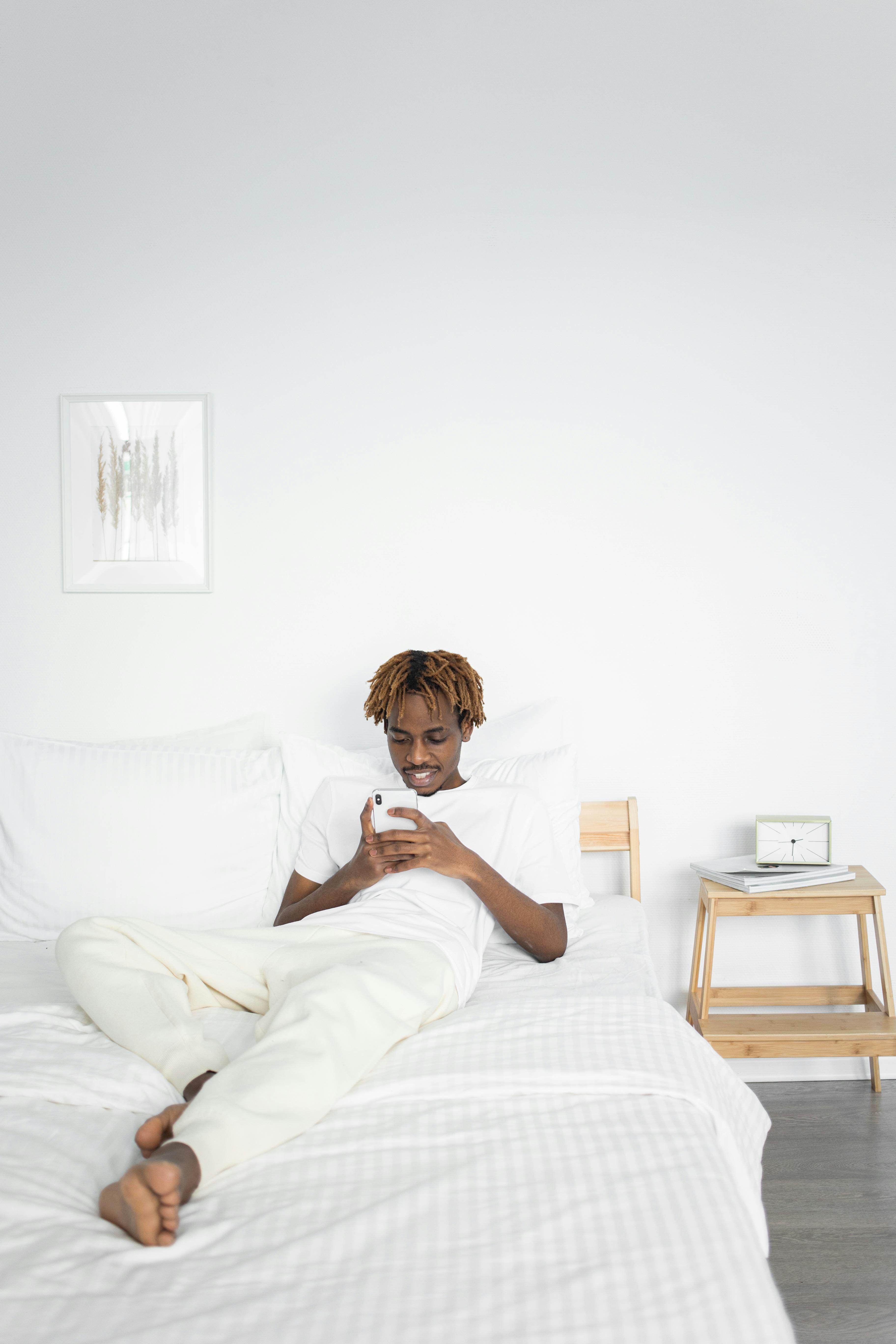 Person Lying in Bed Beside Window · Free Stock Photo