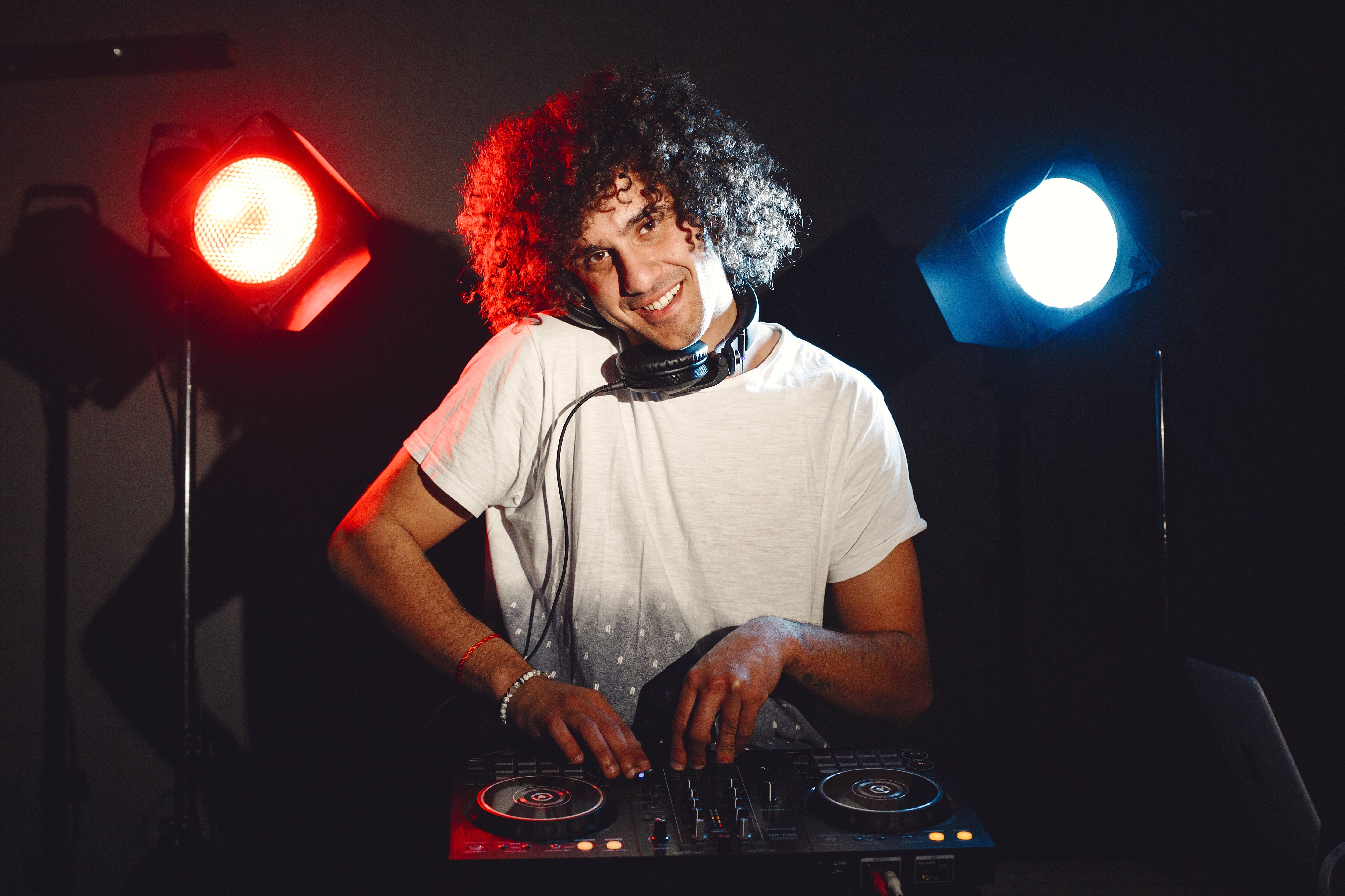 Smiling DJ in Darkness · Free Stock Photo
