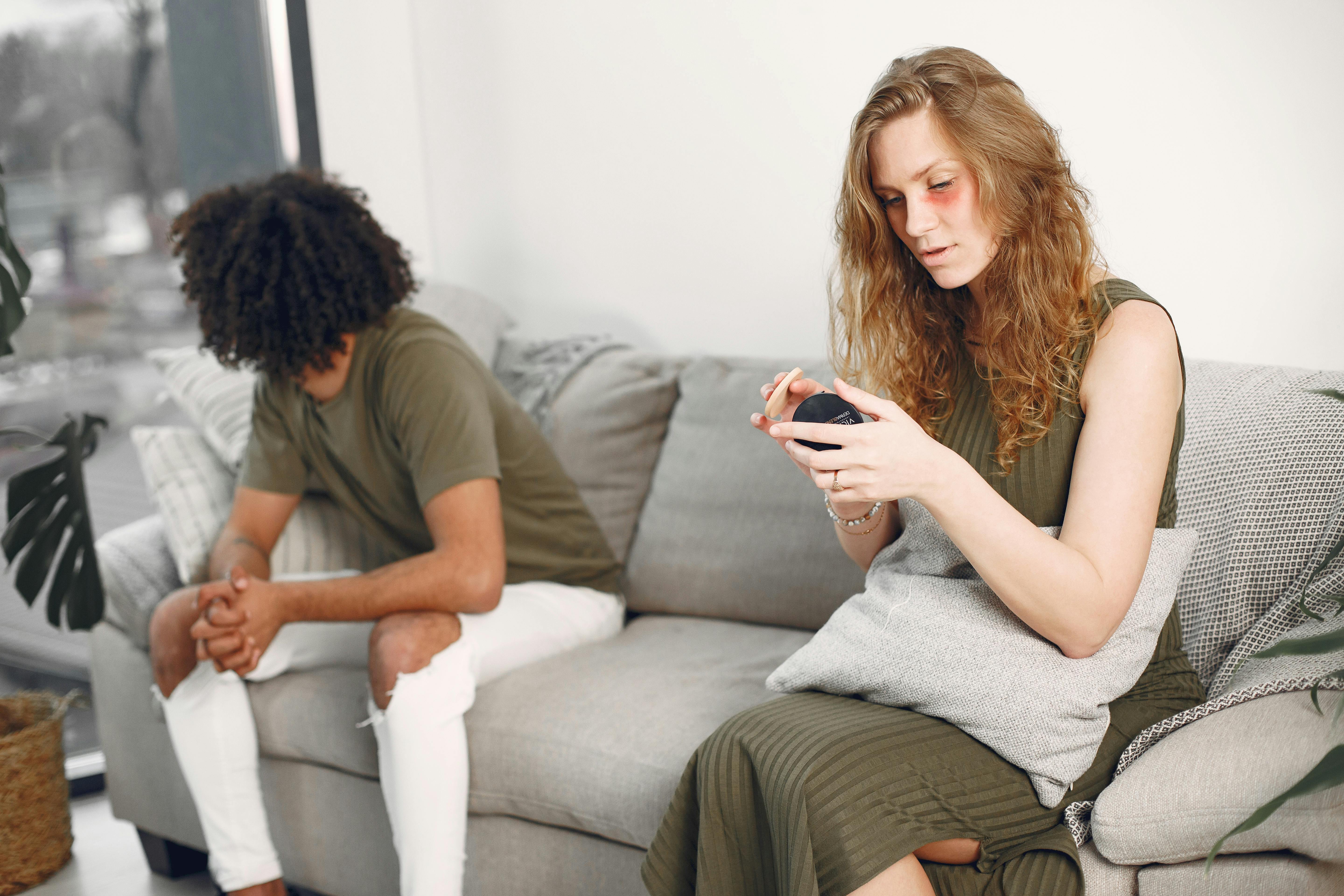 A Bruised Woman Sitting on a Sofa · Free Stock Photo