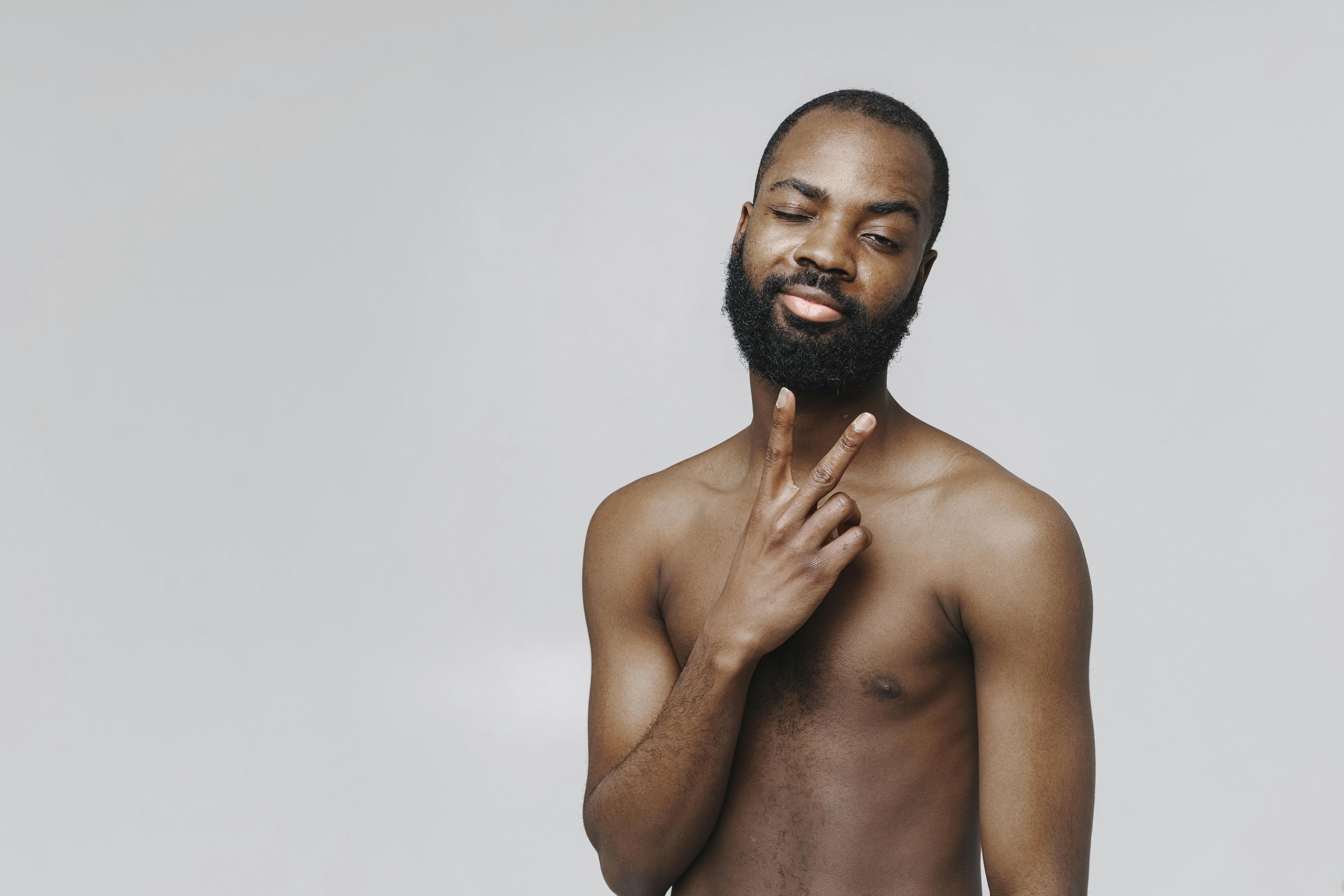A Shirtless Man Doing Peace Sign · Free Stock Photo