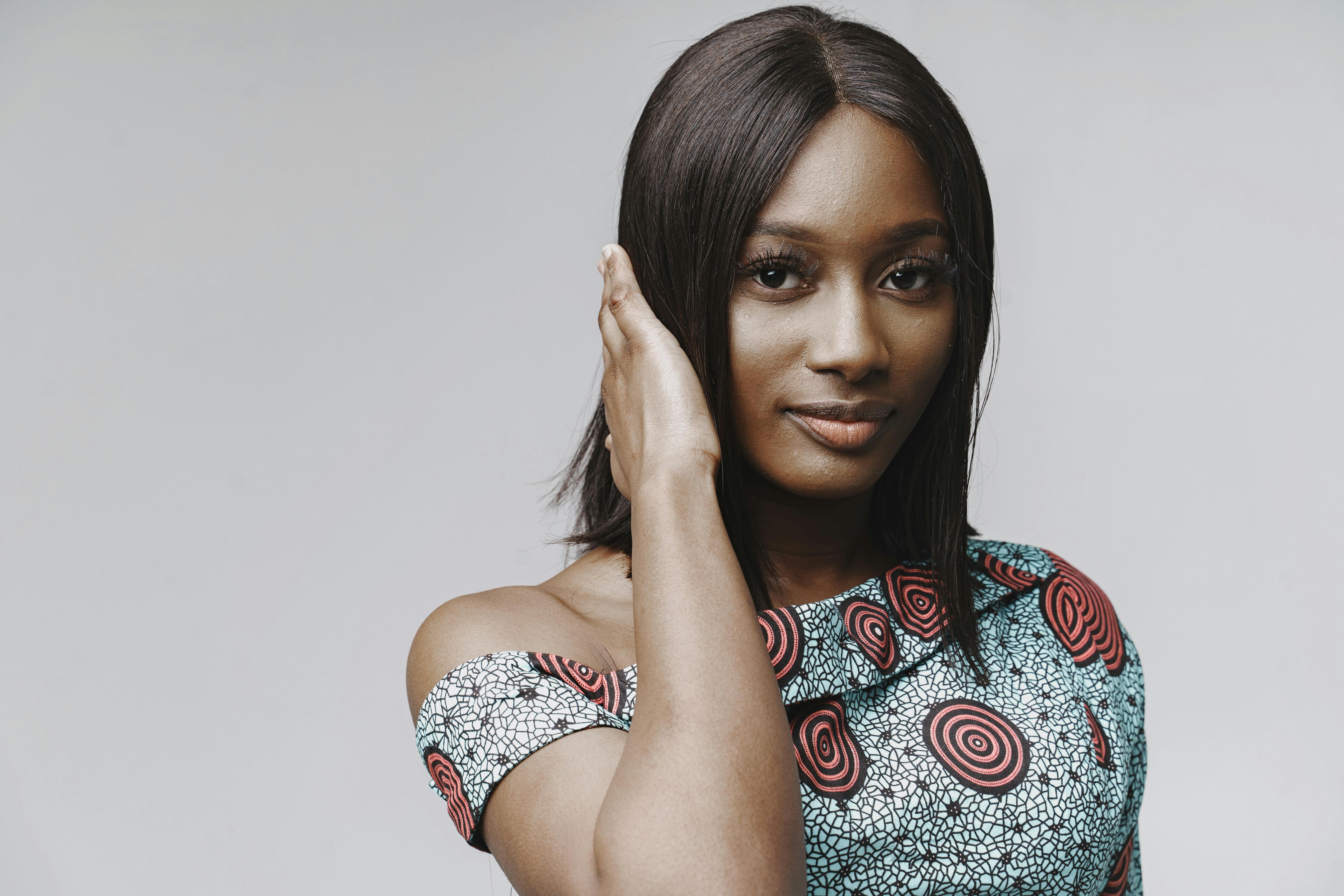 A Beautiful Woman Smiling with Her Hand on Her Head · Free Stock Photo