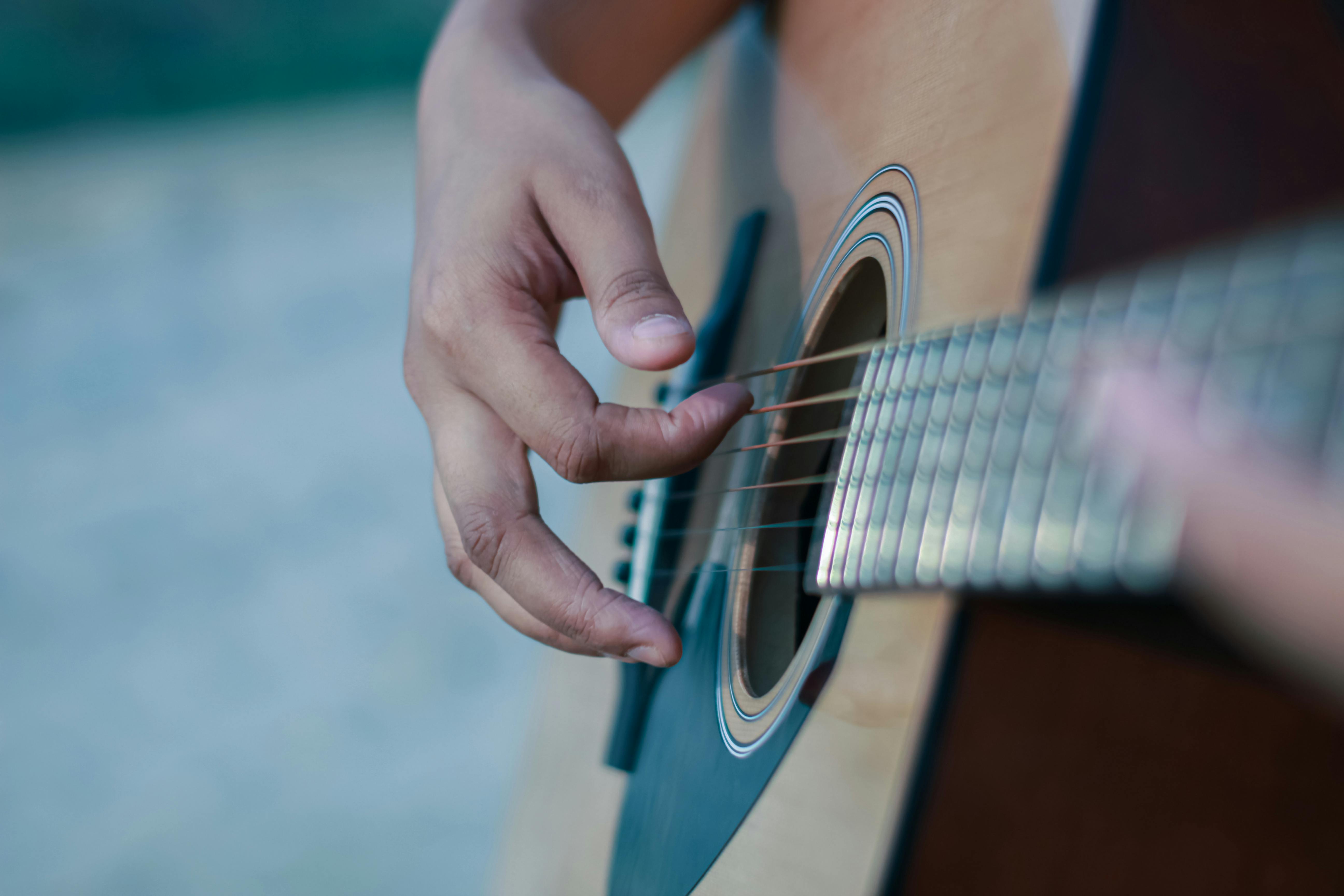 Person Playing Acoustic Guitar · Free Stock Photo
