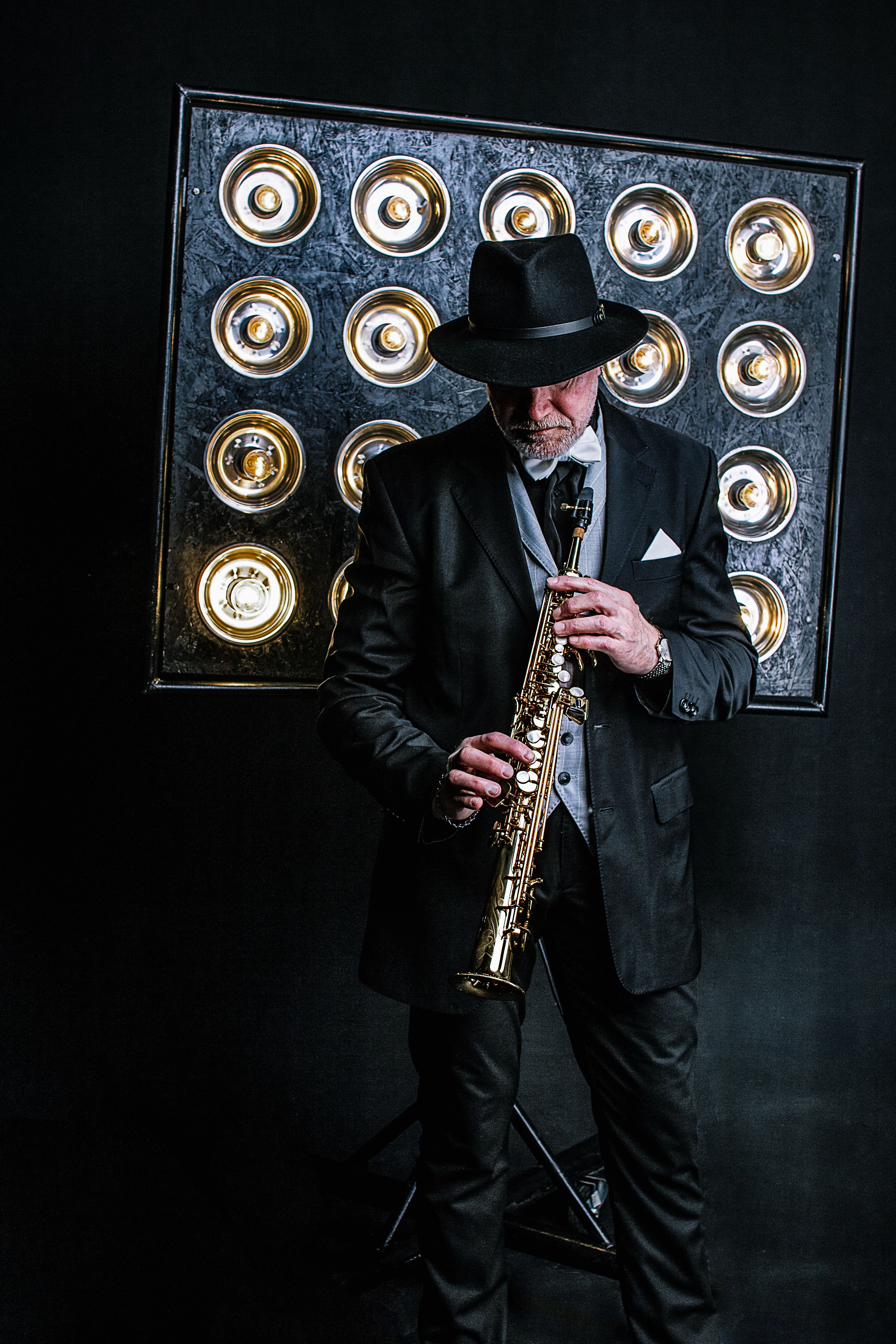Old Man in Suit Playing Jazz Instrument · Free Stock Photo