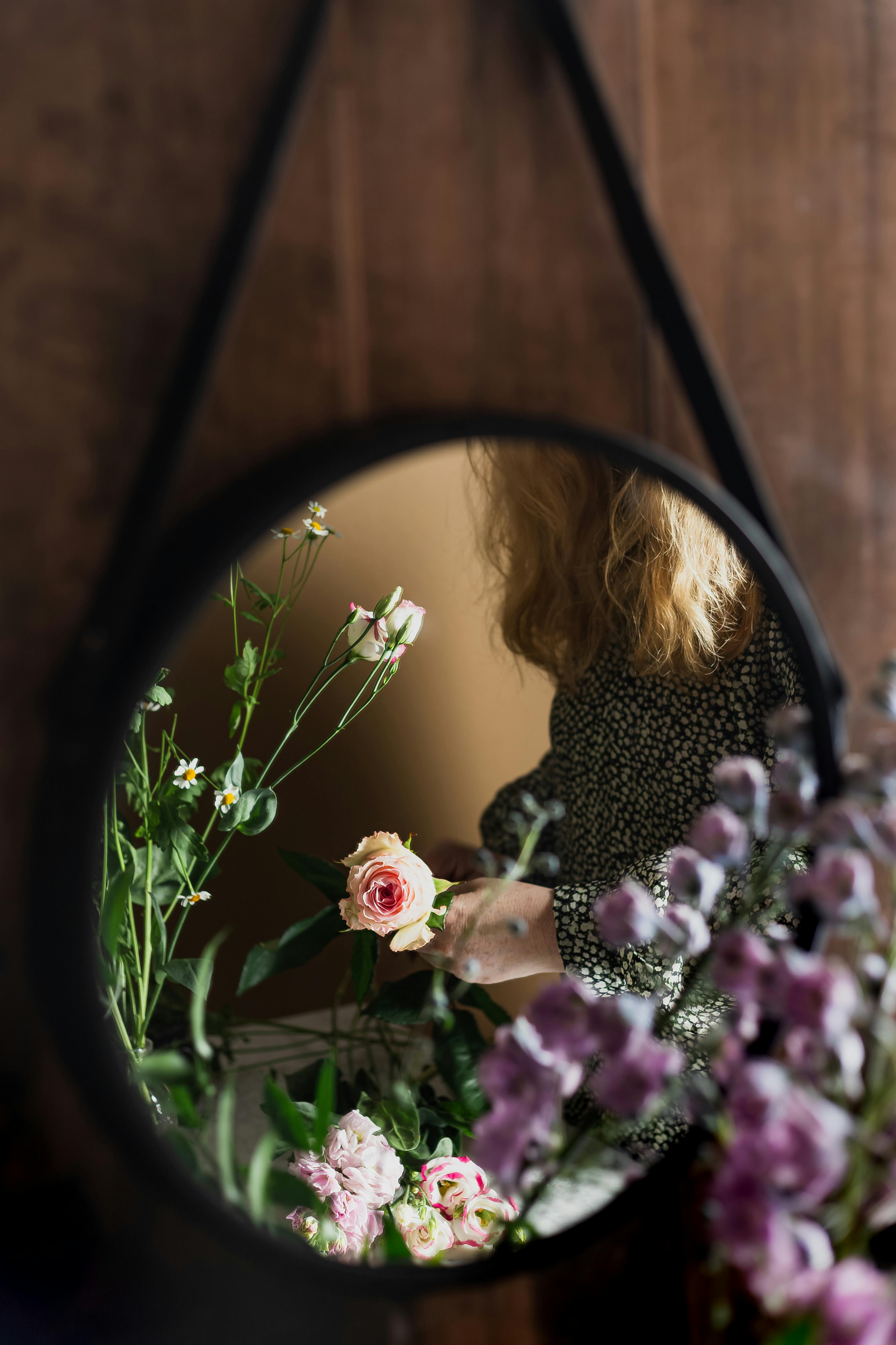 White Petaled Flower Reflection From Small Round Mirror · Free Stock Photo