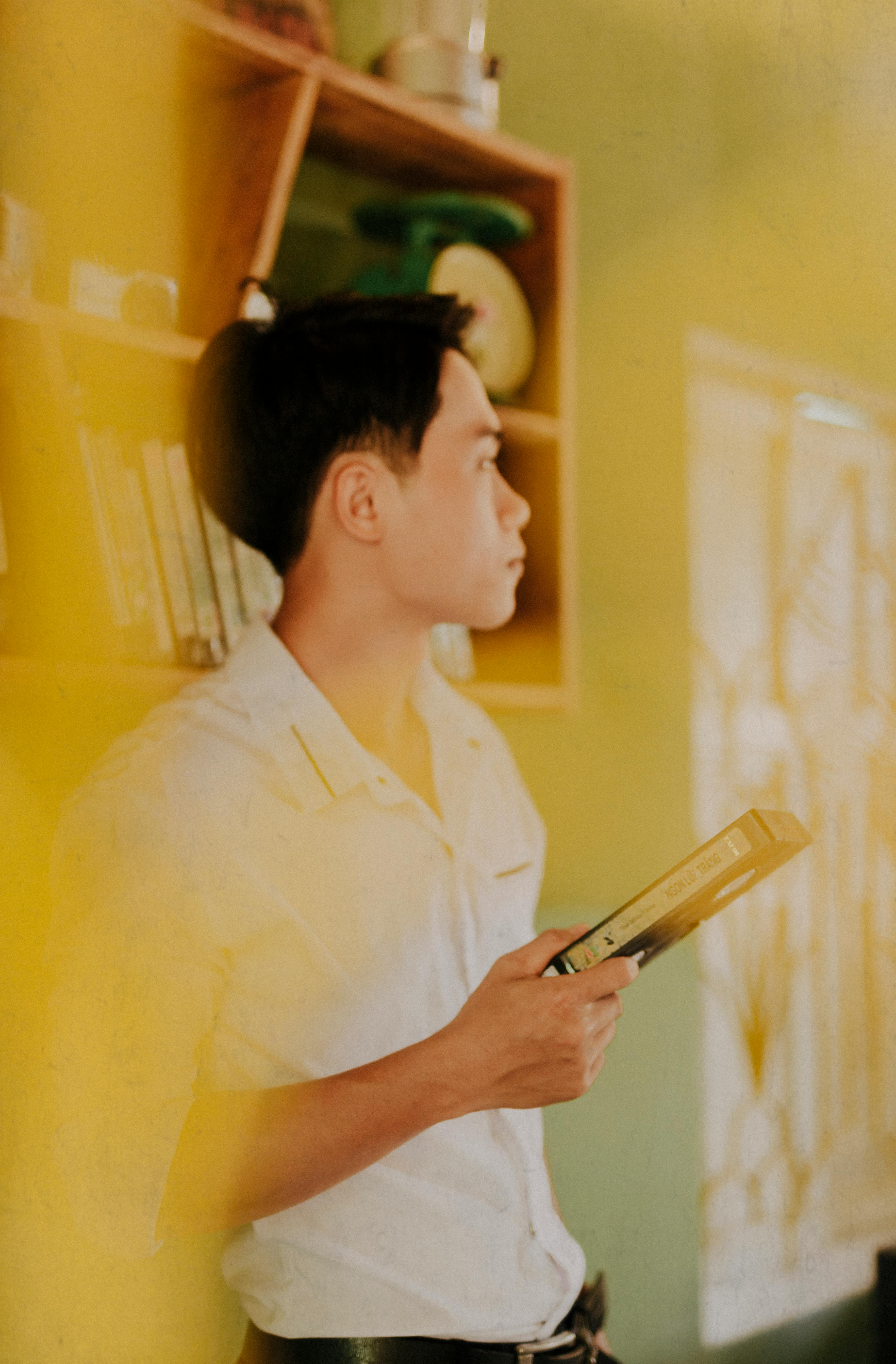 Photo of a Man Holding a VHS Tape · Free Stock Photo