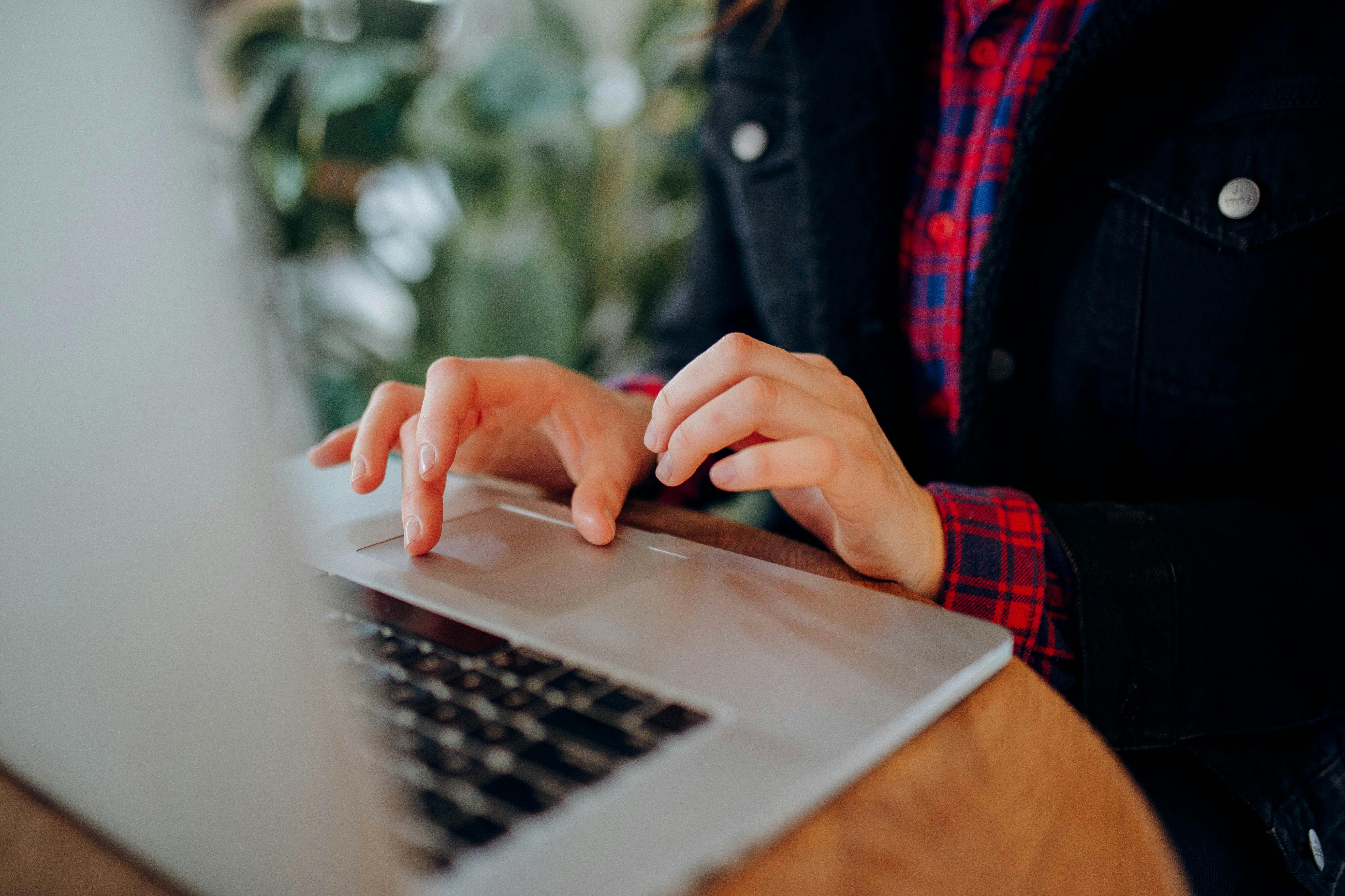 Close-Up Shot of a Person Using a Laptop · Free Stock Photo