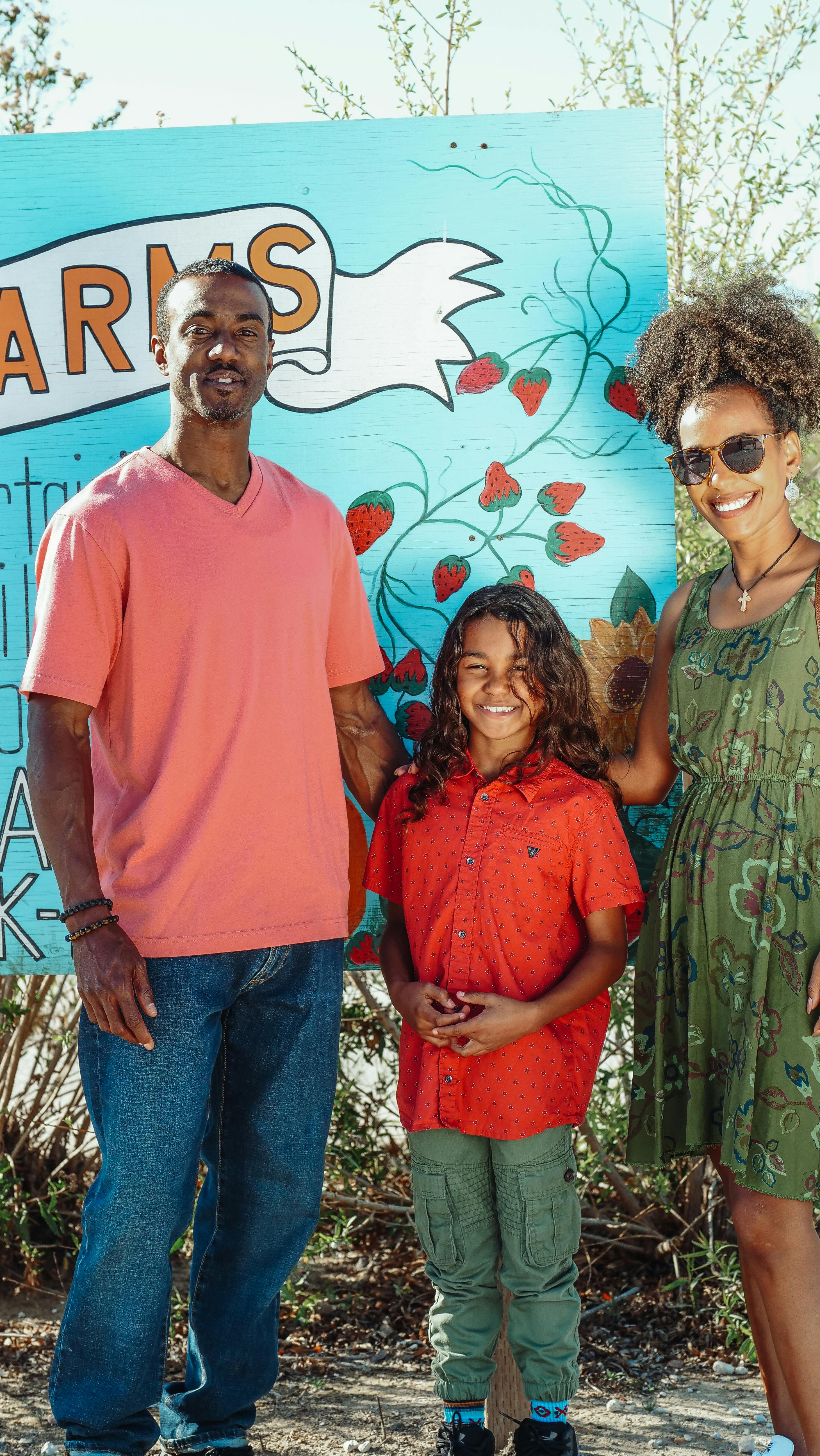 A Happy Family Standing Together while Smiling · Free Stock Photo