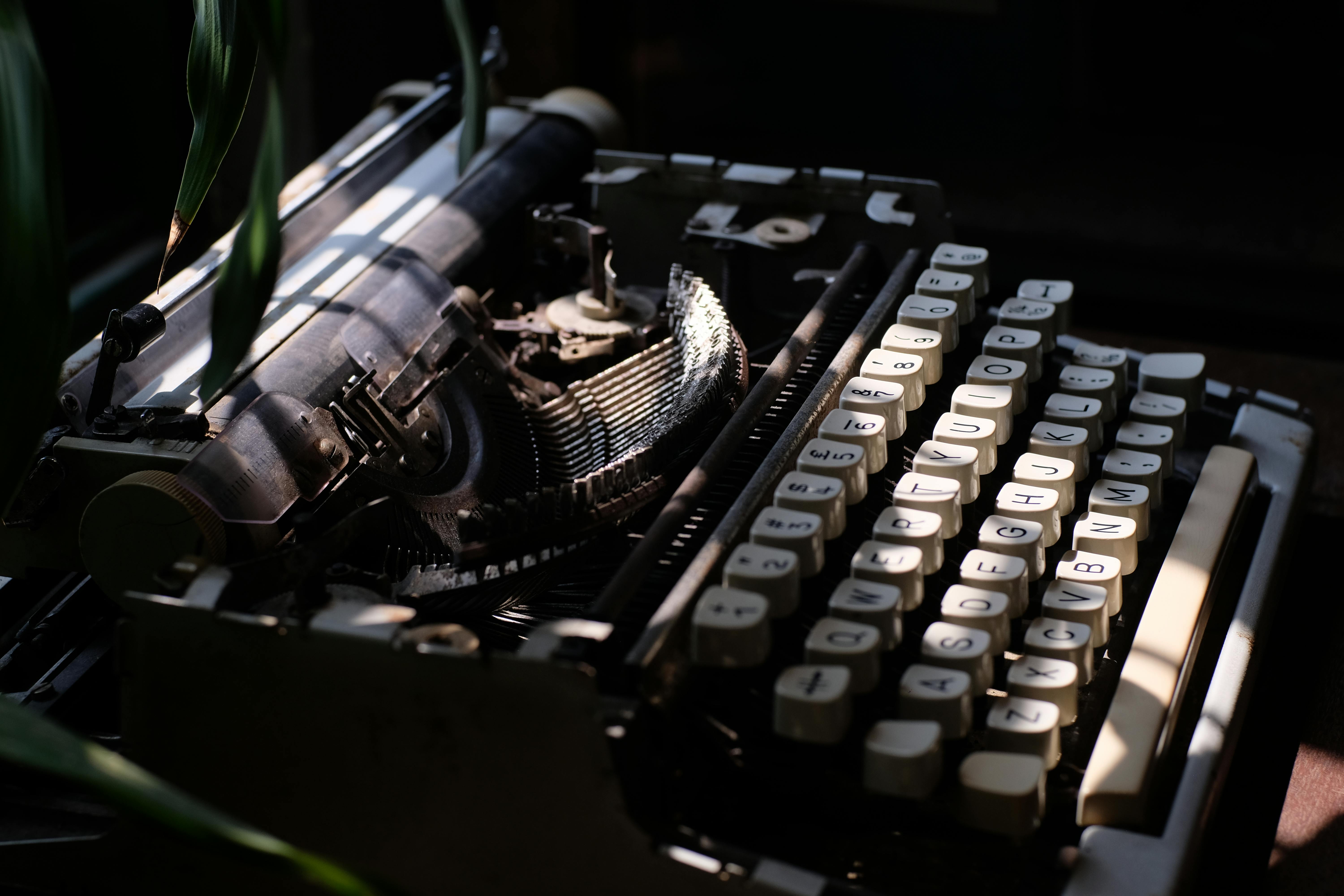 Black and White Typewriter on Black Table · Free Stock Photo