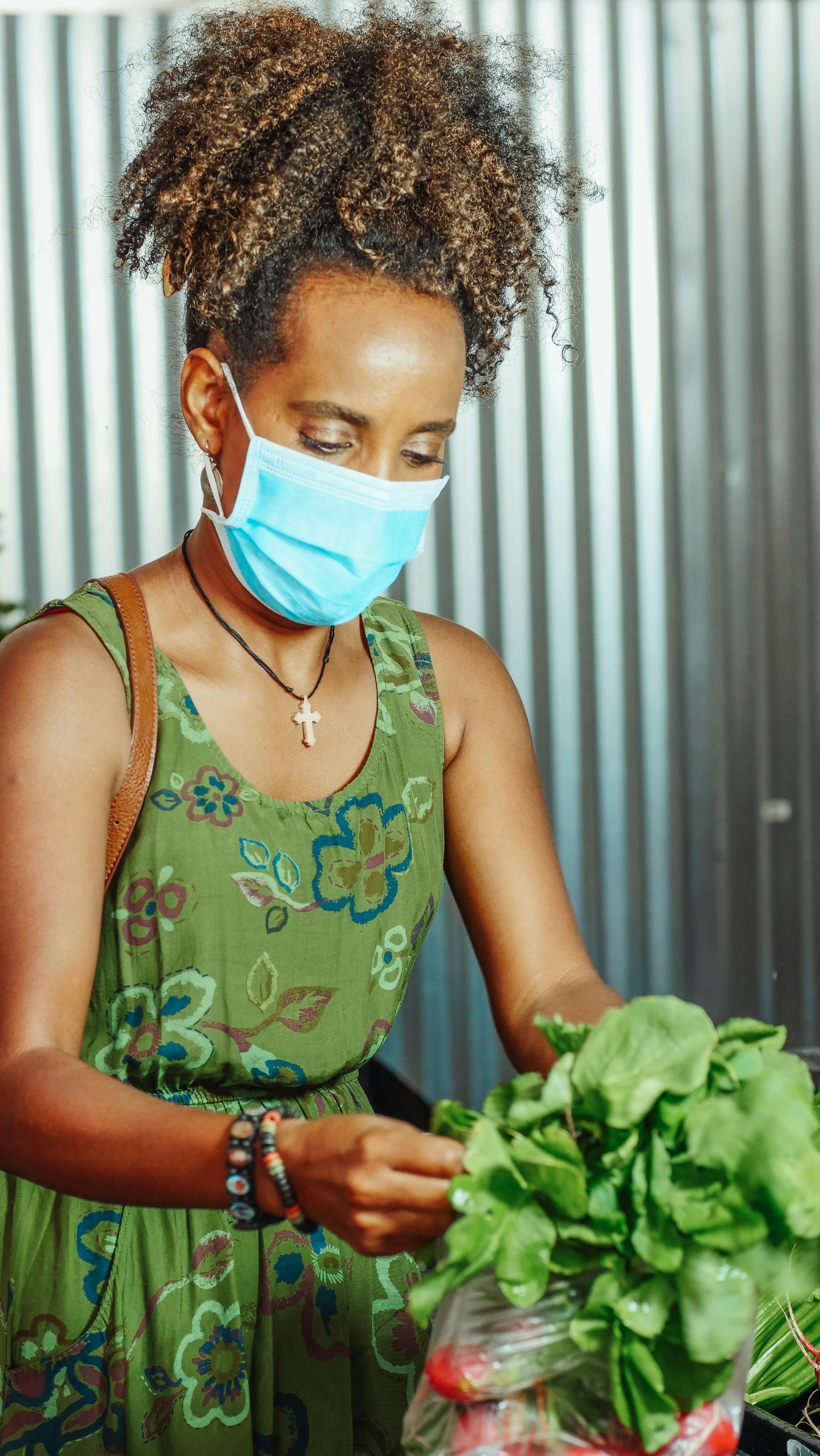 Woman Holding a Plastic Full of Vegetables · Free Stock Photo