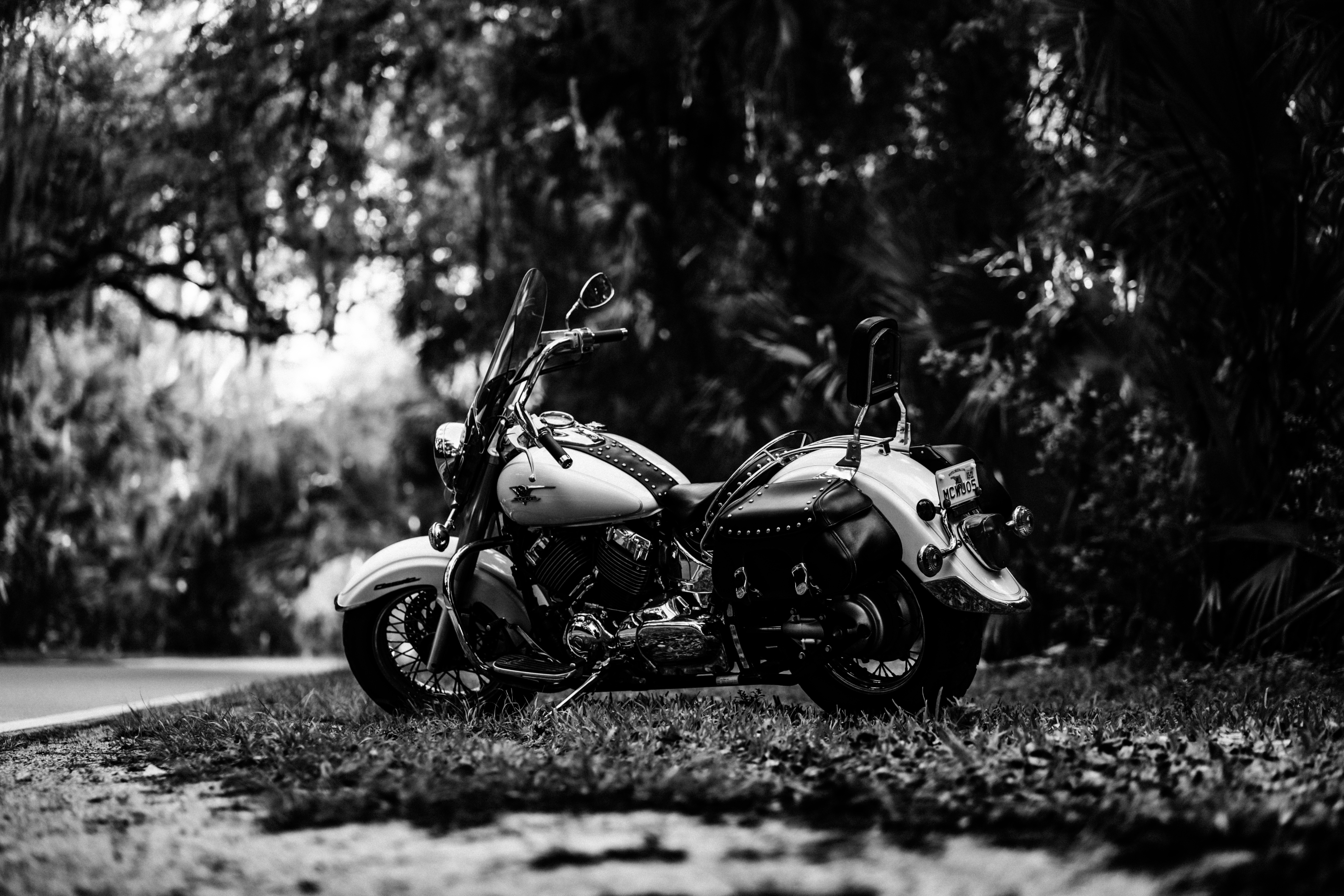 Grayscale Photo of a Motorcycle Parked Outside · Free Stock Photo