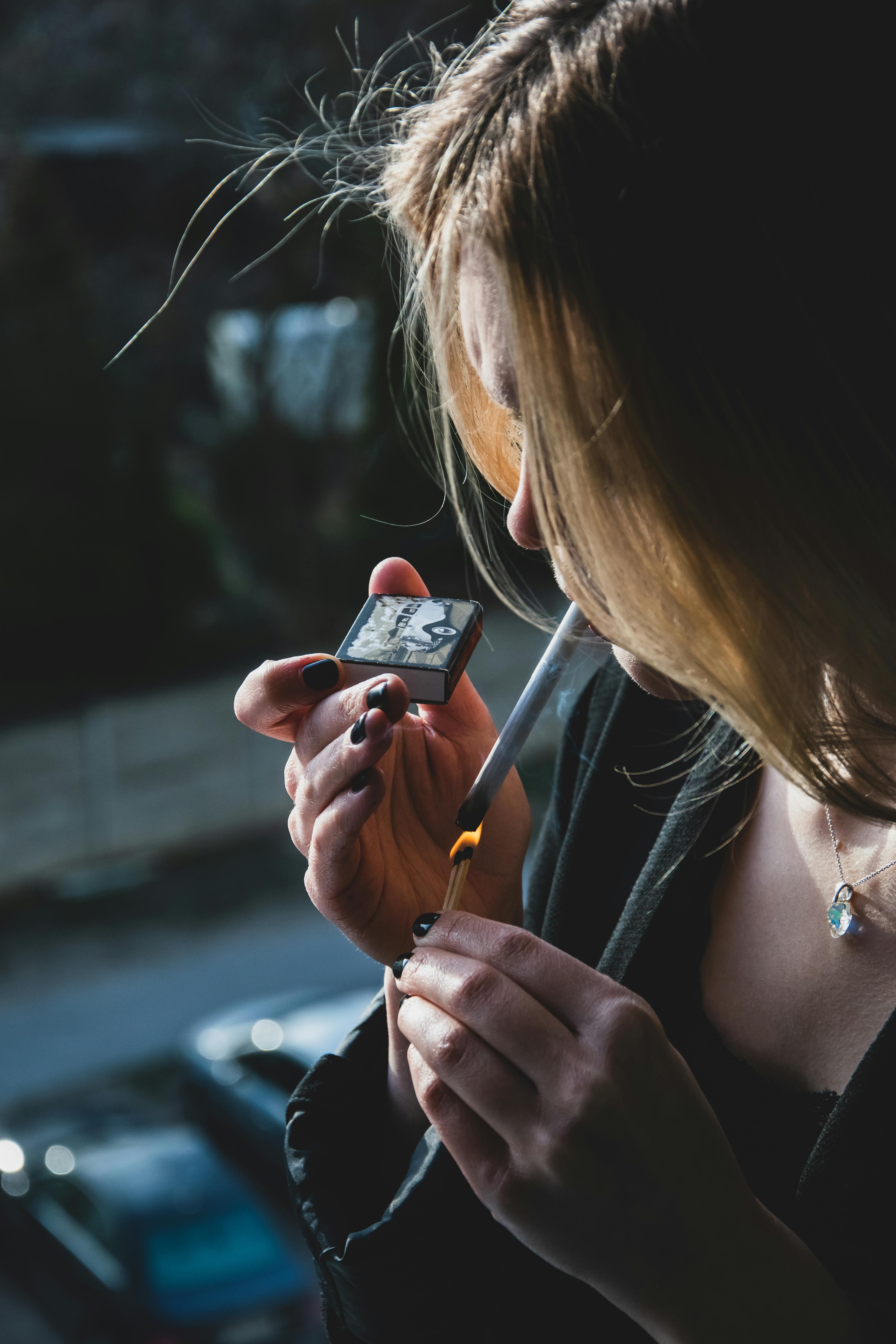 Woman Smoking While Leaning on Wall · Free Stock Photo