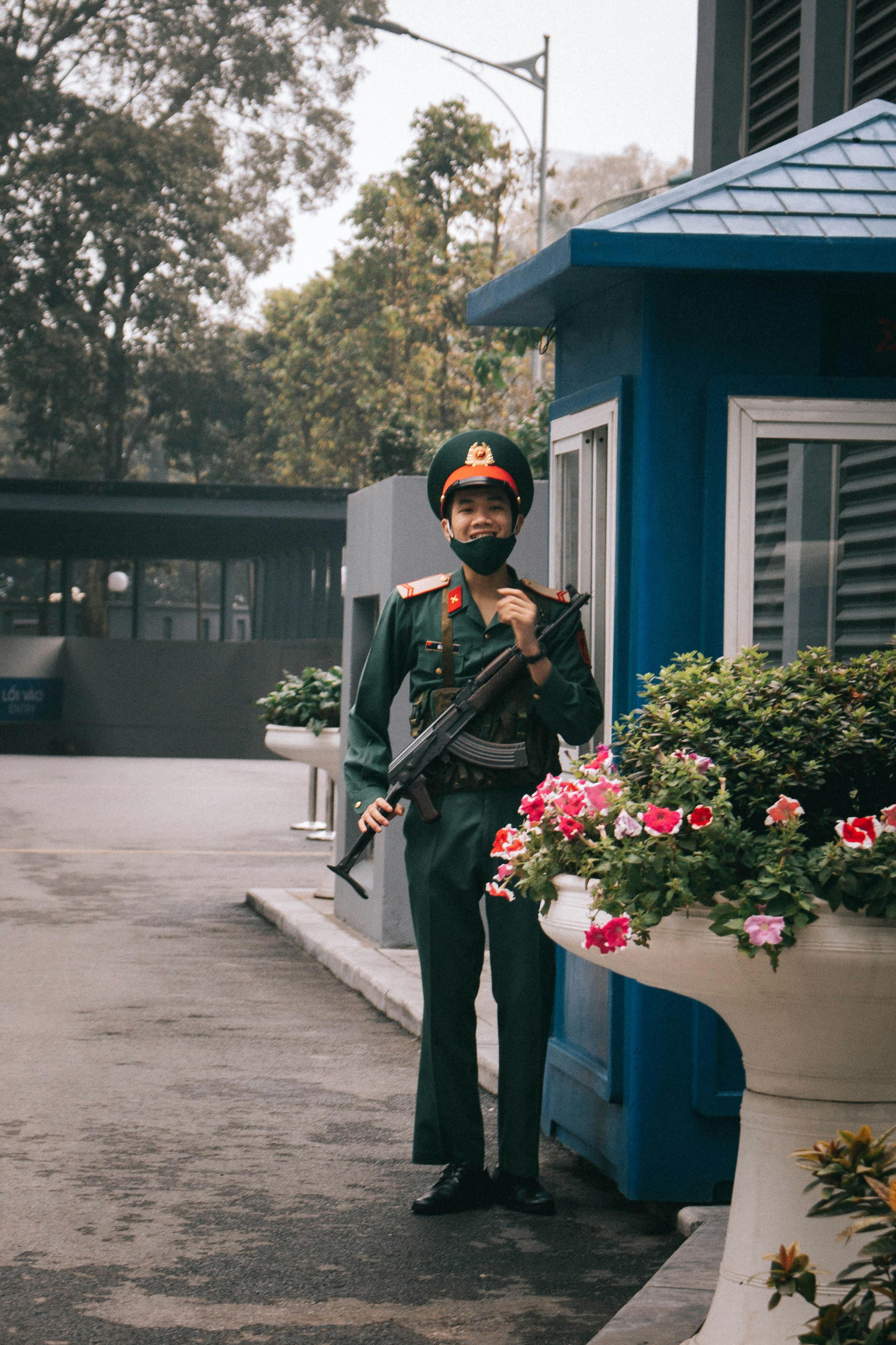 A Military Personnel Holding a Rifle · Free Stock Photo