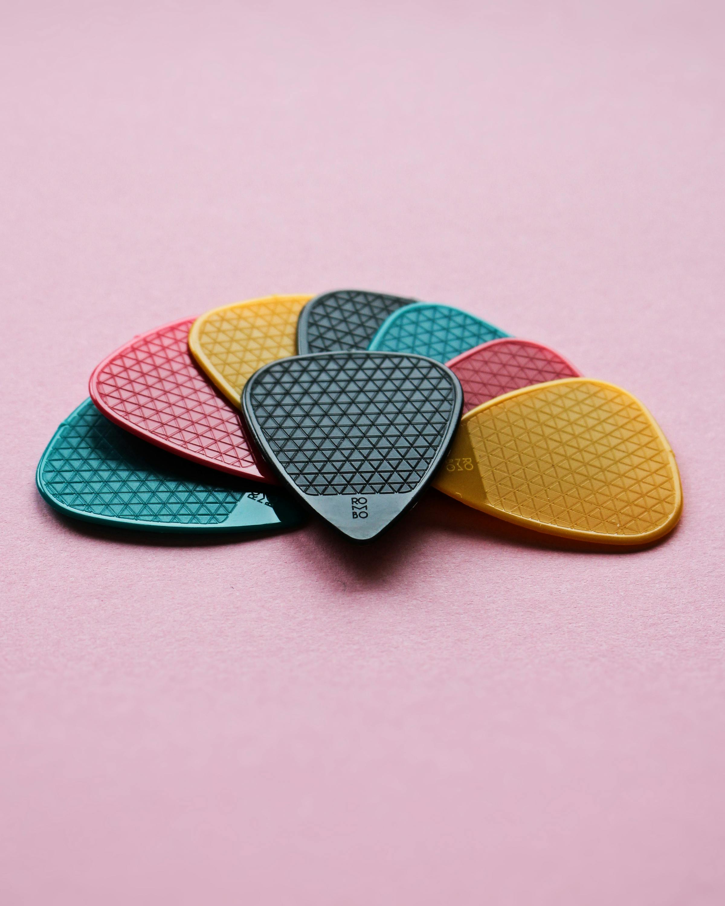 Shallow Focus Photo of Pink Guitar Pick · Free Stock Photo