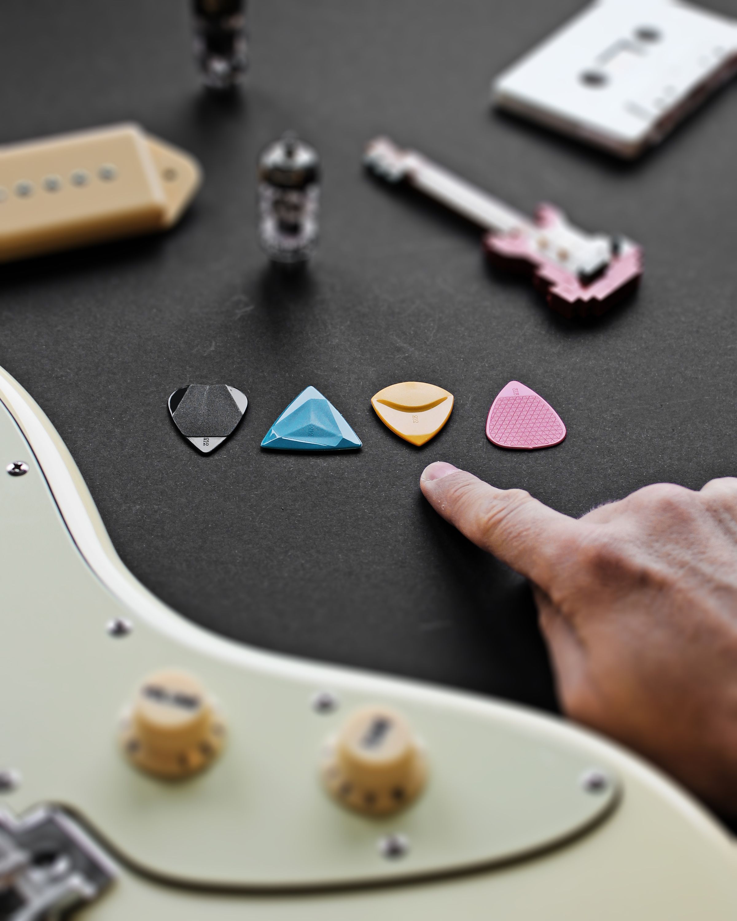 Wooden Hand Holding a Blue Guitar Pick · Free Stock Photo
